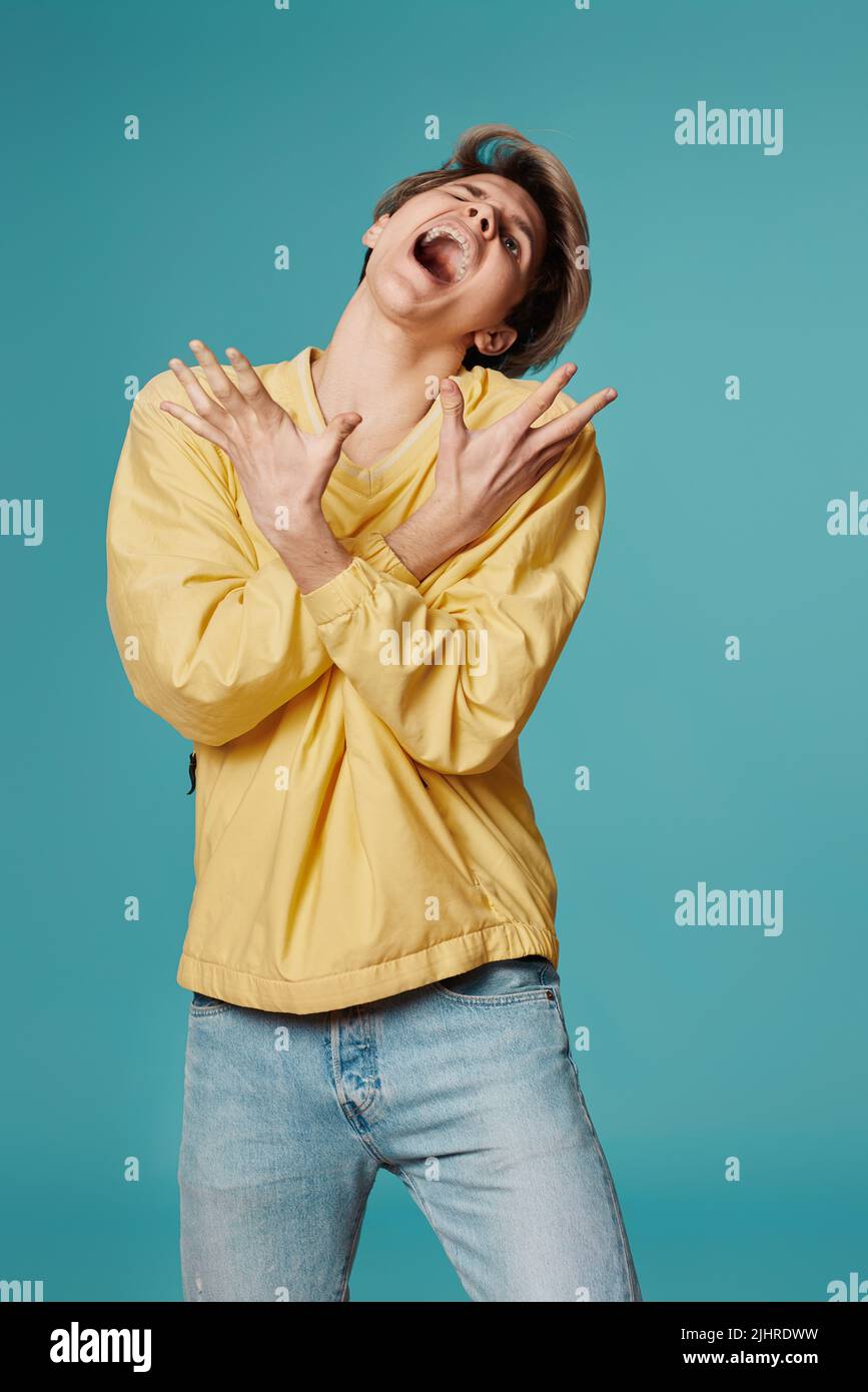 young man in casual yellow clothes dancing Stock Photo - Alamy