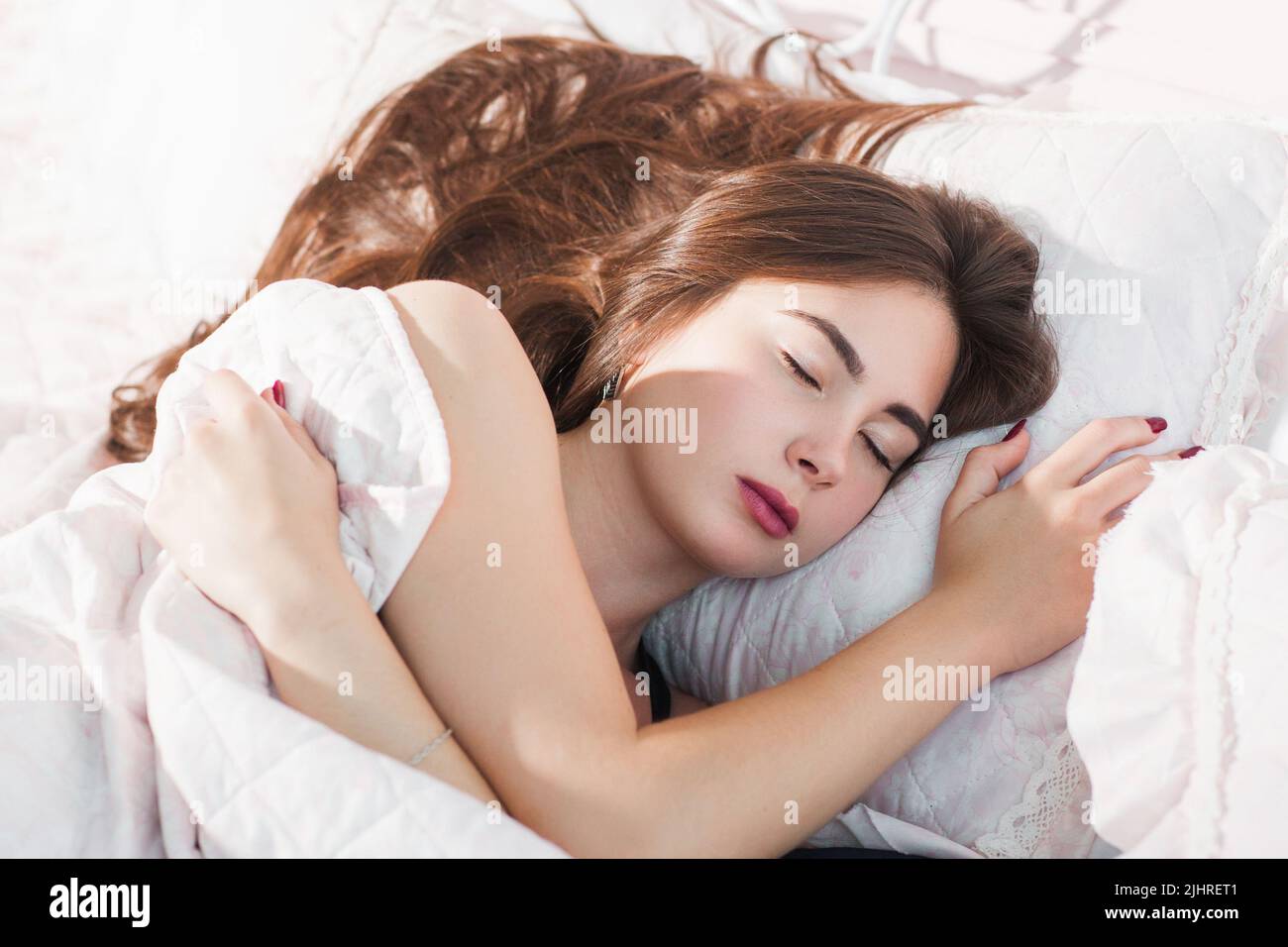 Beautiful woman sleeping in cozy bed Stock Photo - Alamy