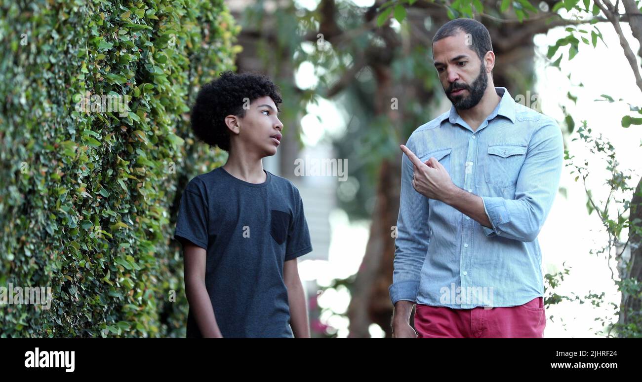 Parent and child walking together. Father giving advice to son, dad and ...