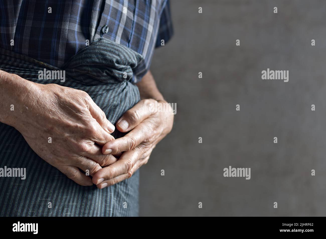 Asian elder man suffering from abdominal pain. It can be caused by ...