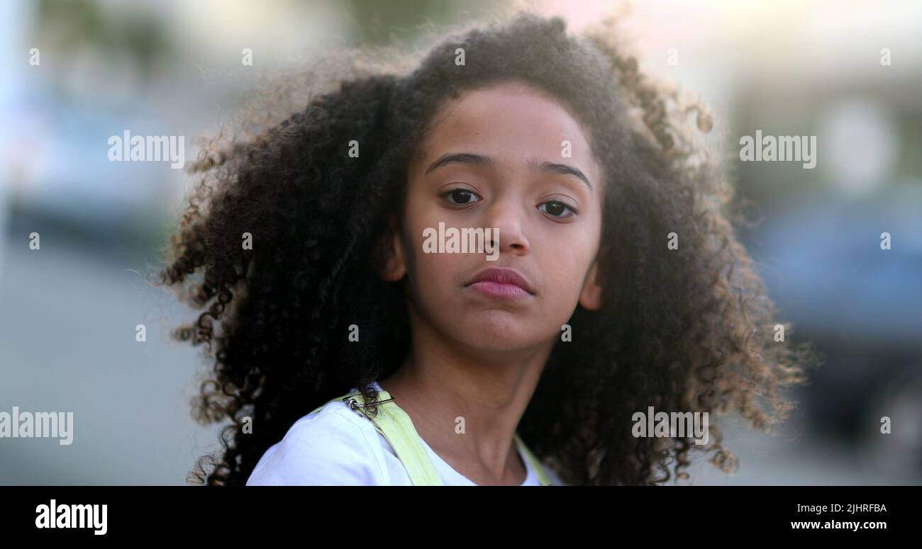 Serious hispanic black ethnicity little girl, moody child changing ...