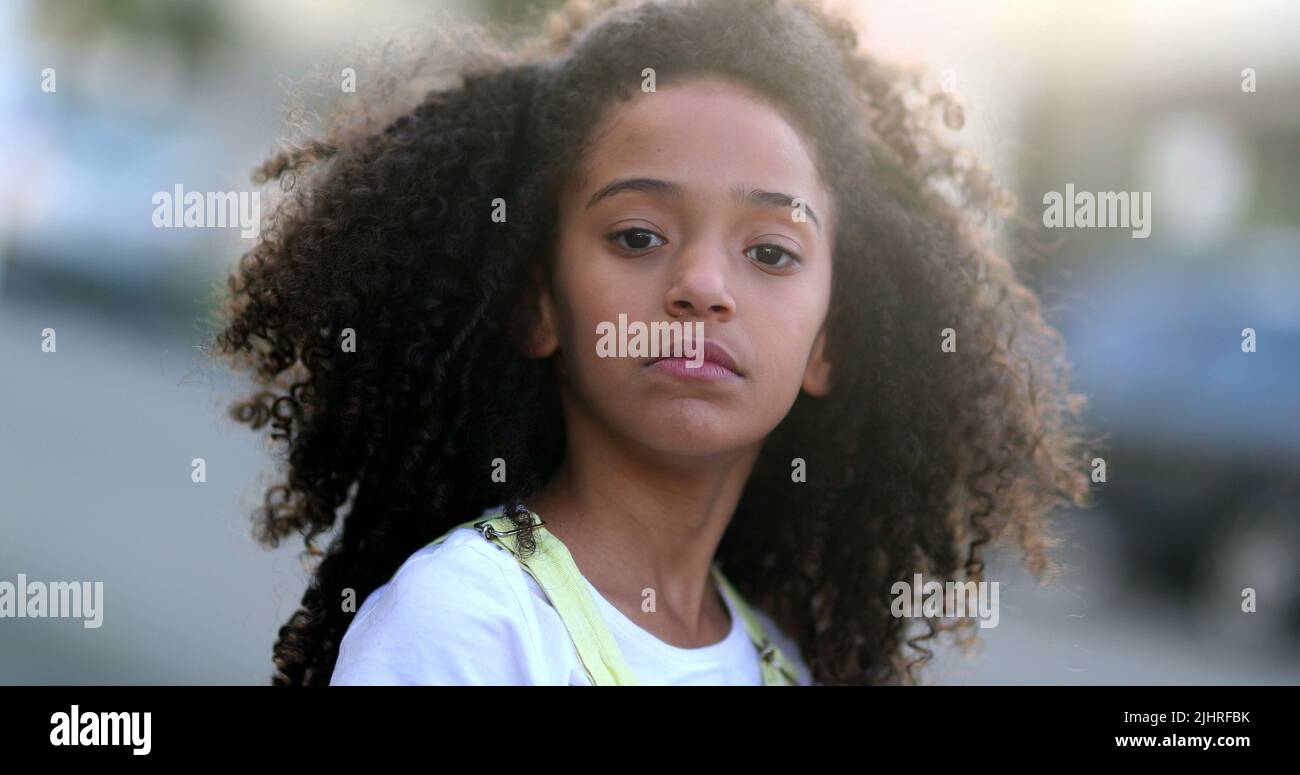 Serious hispanic black ethnicity little girl, moody child changing ...