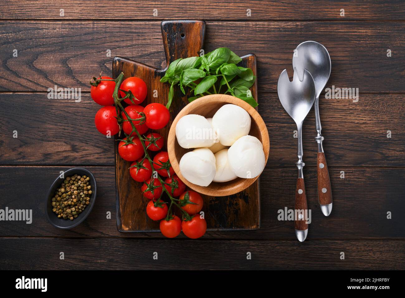 Caprese salad, ingredients for cooking. Cutting wooden board with ...