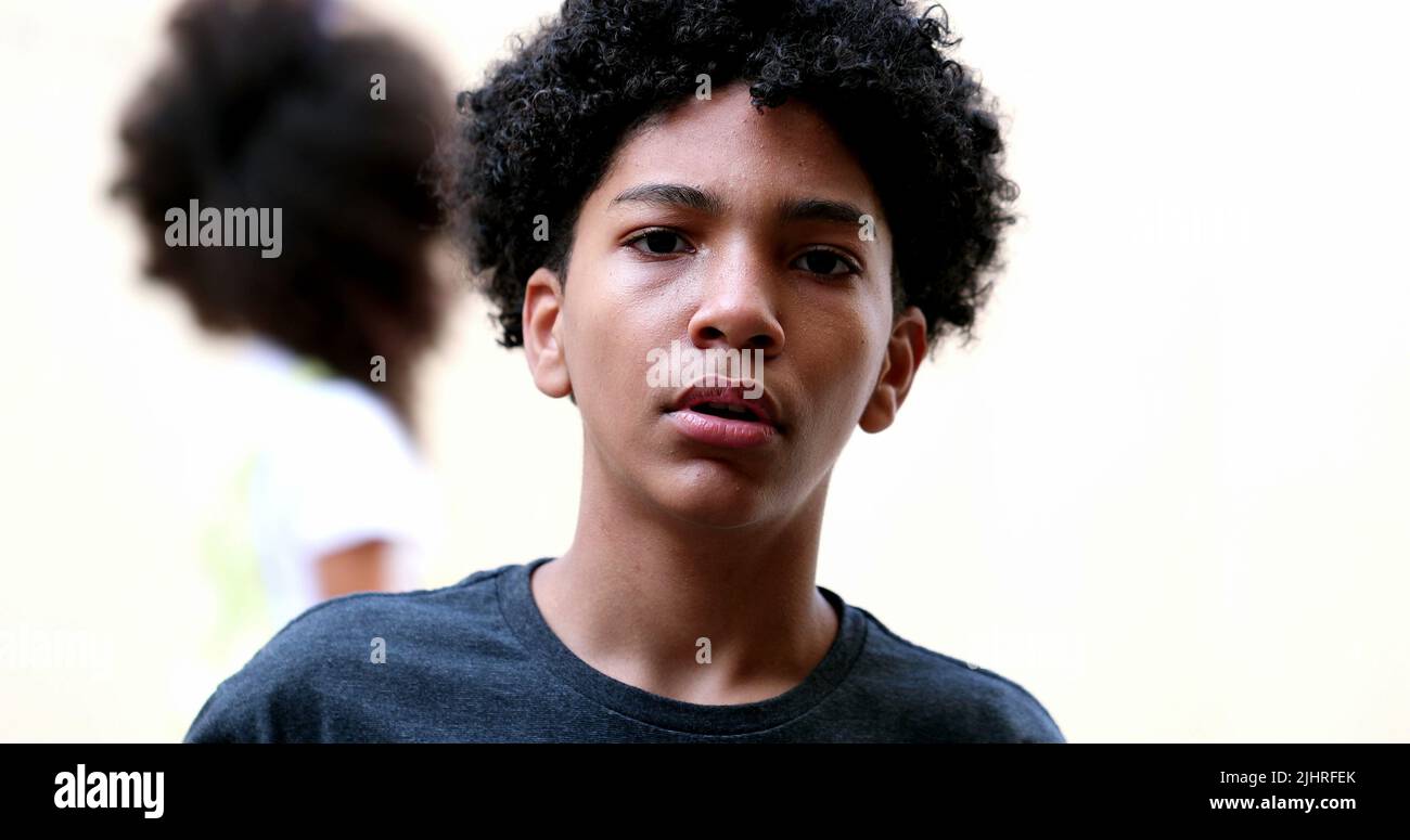 Serious Hispanic young boy portrait face staring at camera Stock Photo ...