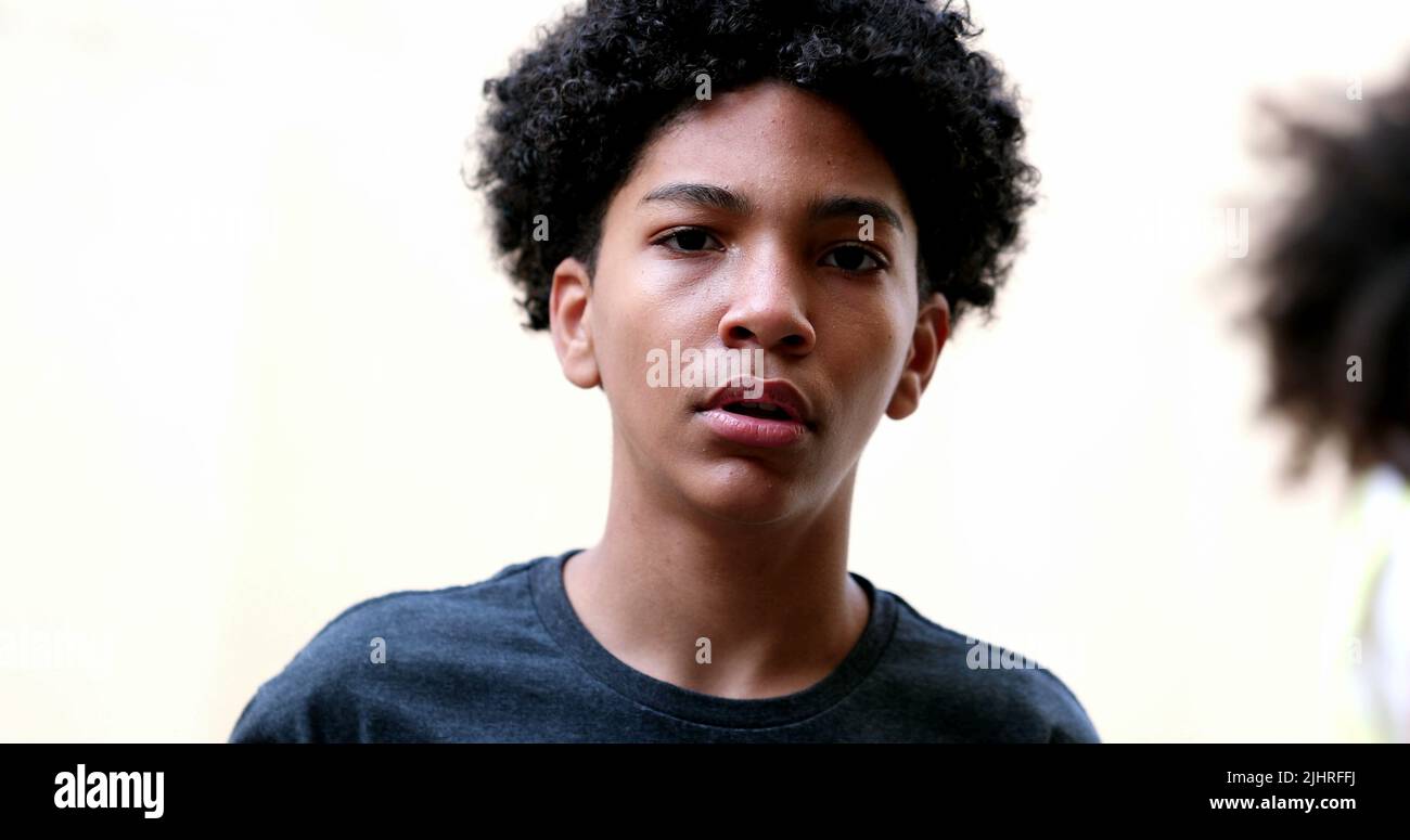 Serious Hispanic young boy portrait face staring at camera Stock Photo ...