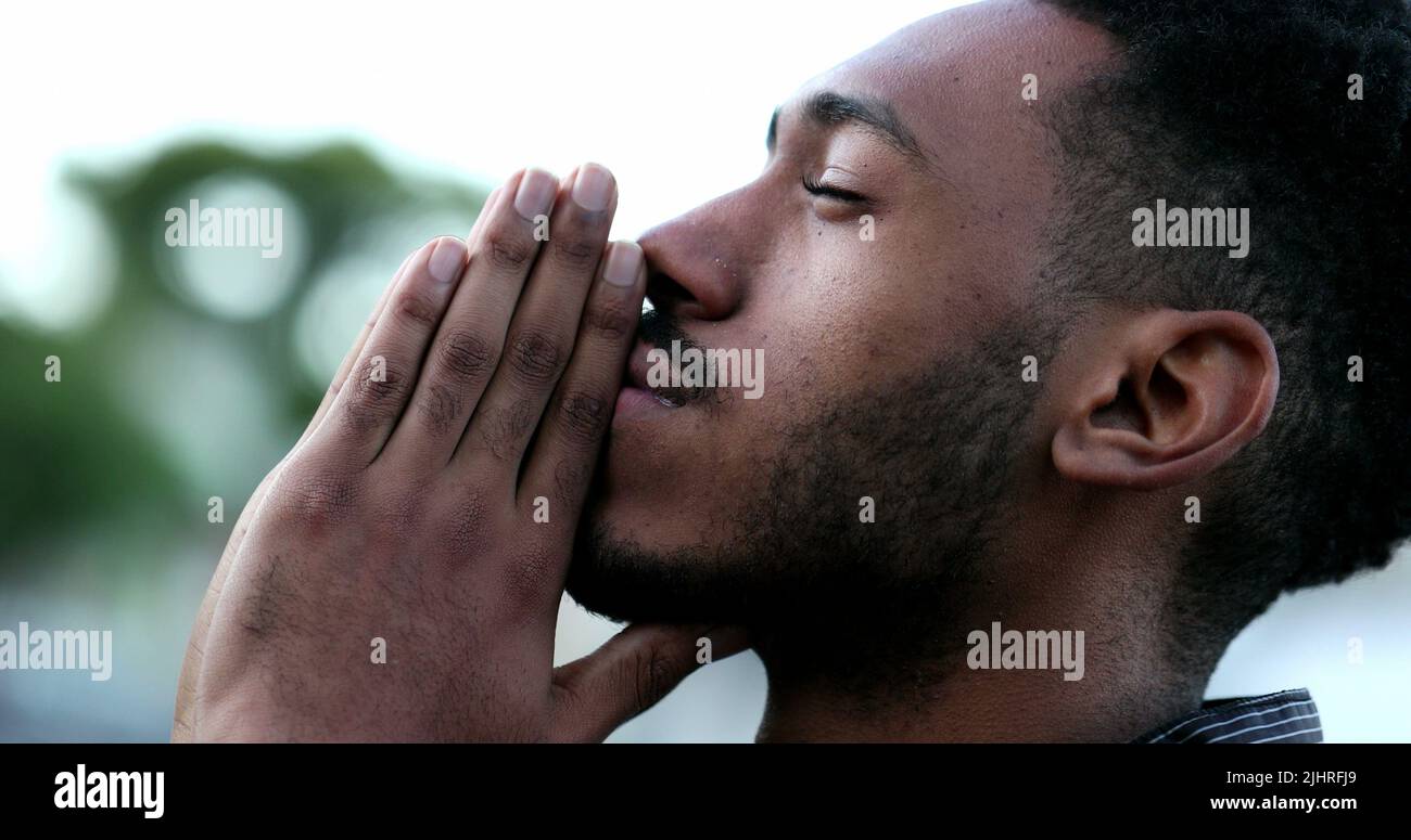 Spiritual young black African man praying to GOD. Person looking to sky ...