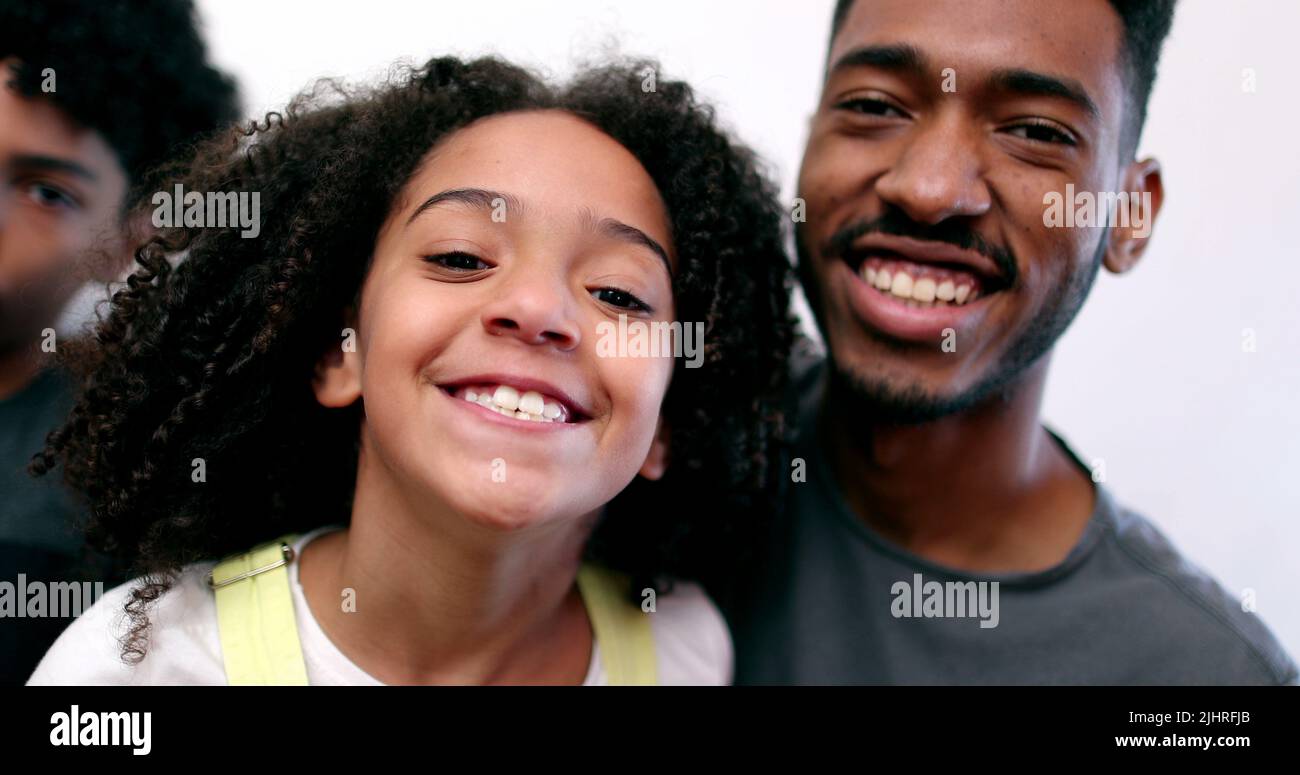 Siblings smiling at camera. Mixed race ethnically diverse brother and ...