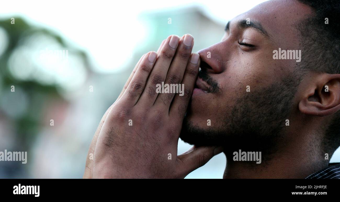 Spiritual young black African man praying to GOD. Person looking to sky ...