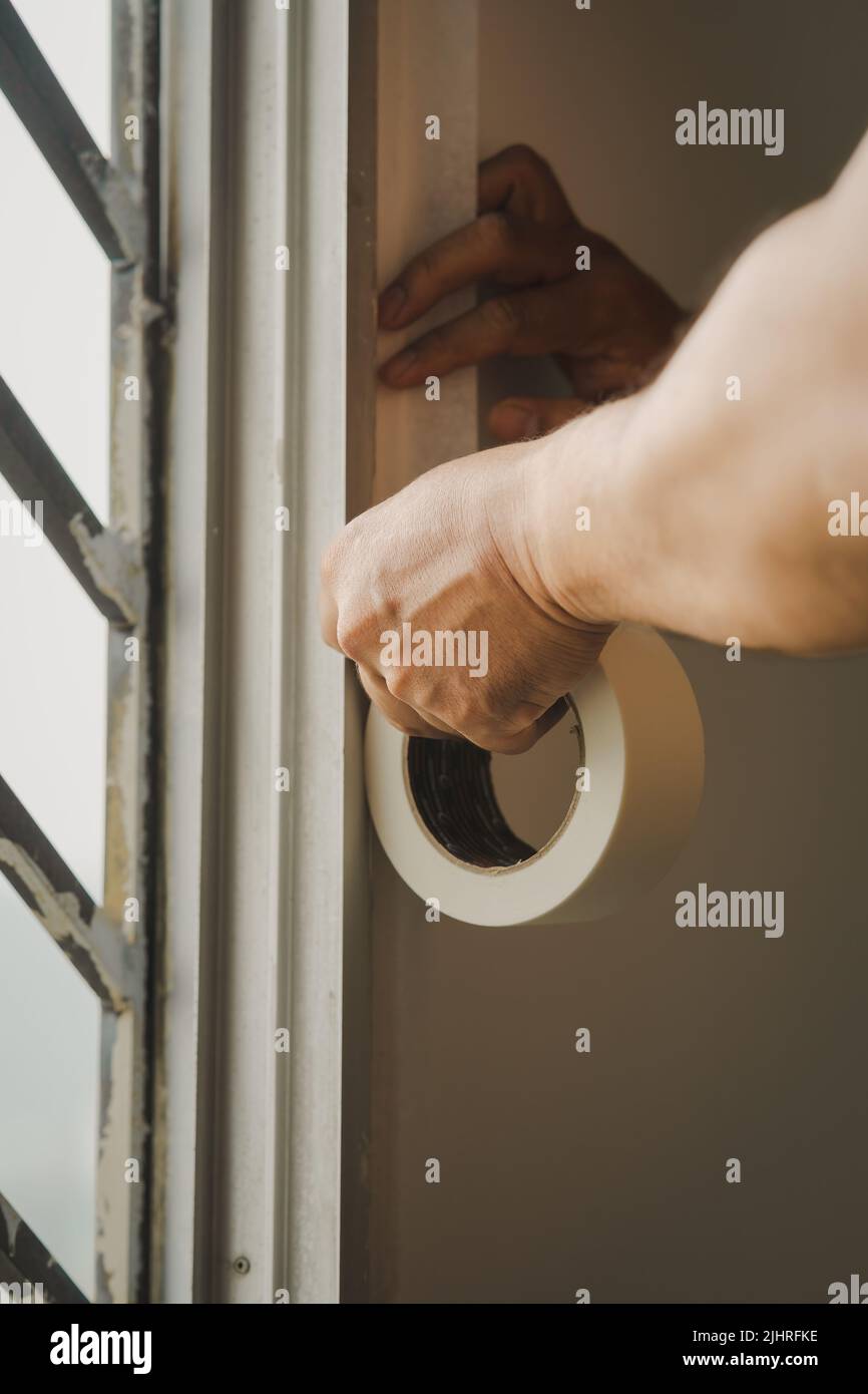 Hand pasting thef masking tape to the wall. Perfect sharp line between ...