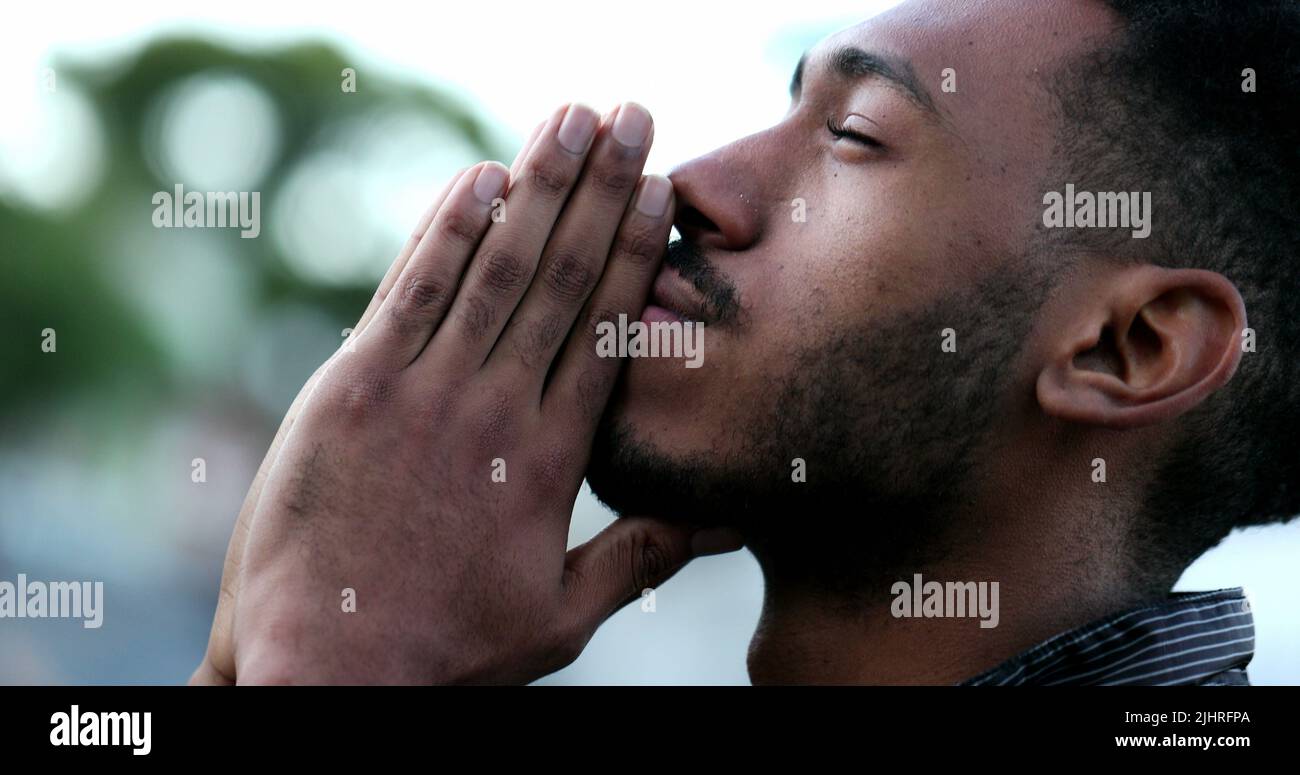 Spiritual young black African man praying to GOD. Person looking to sky ...