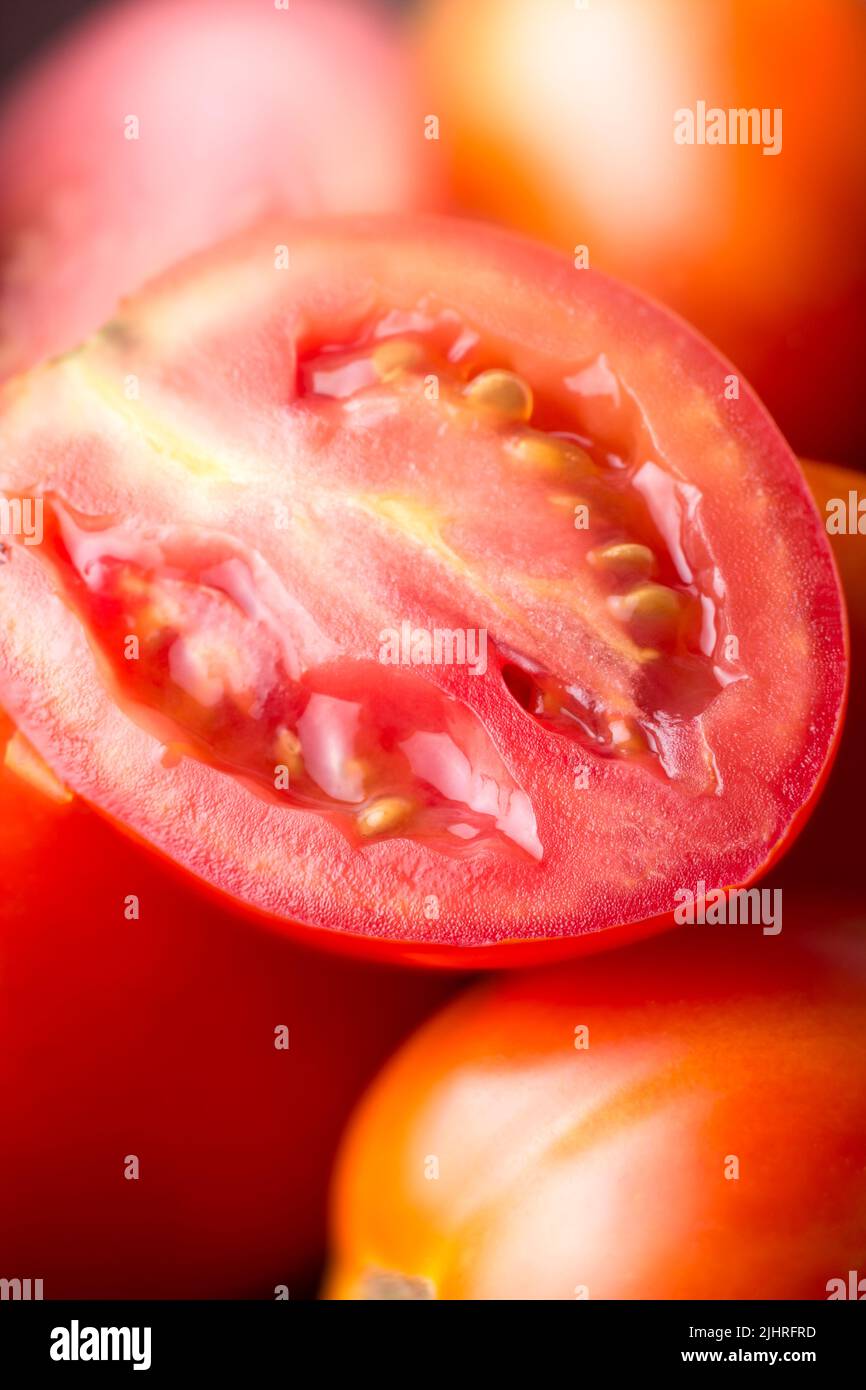 slice of tomato, closeup view of freshly harvested red berries, taken ...