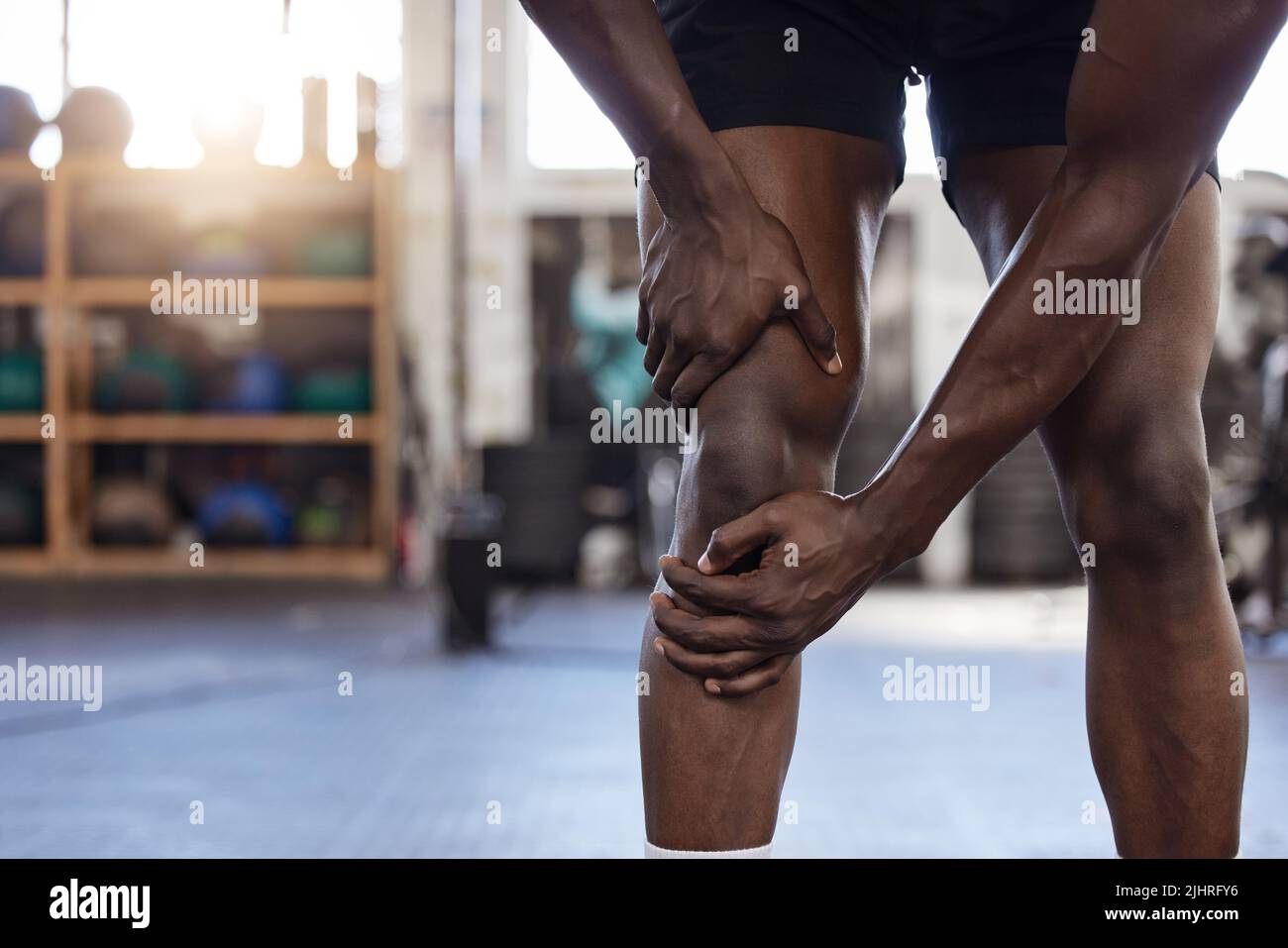 Closeup of one unknown african american athlete suffering from knee ...
