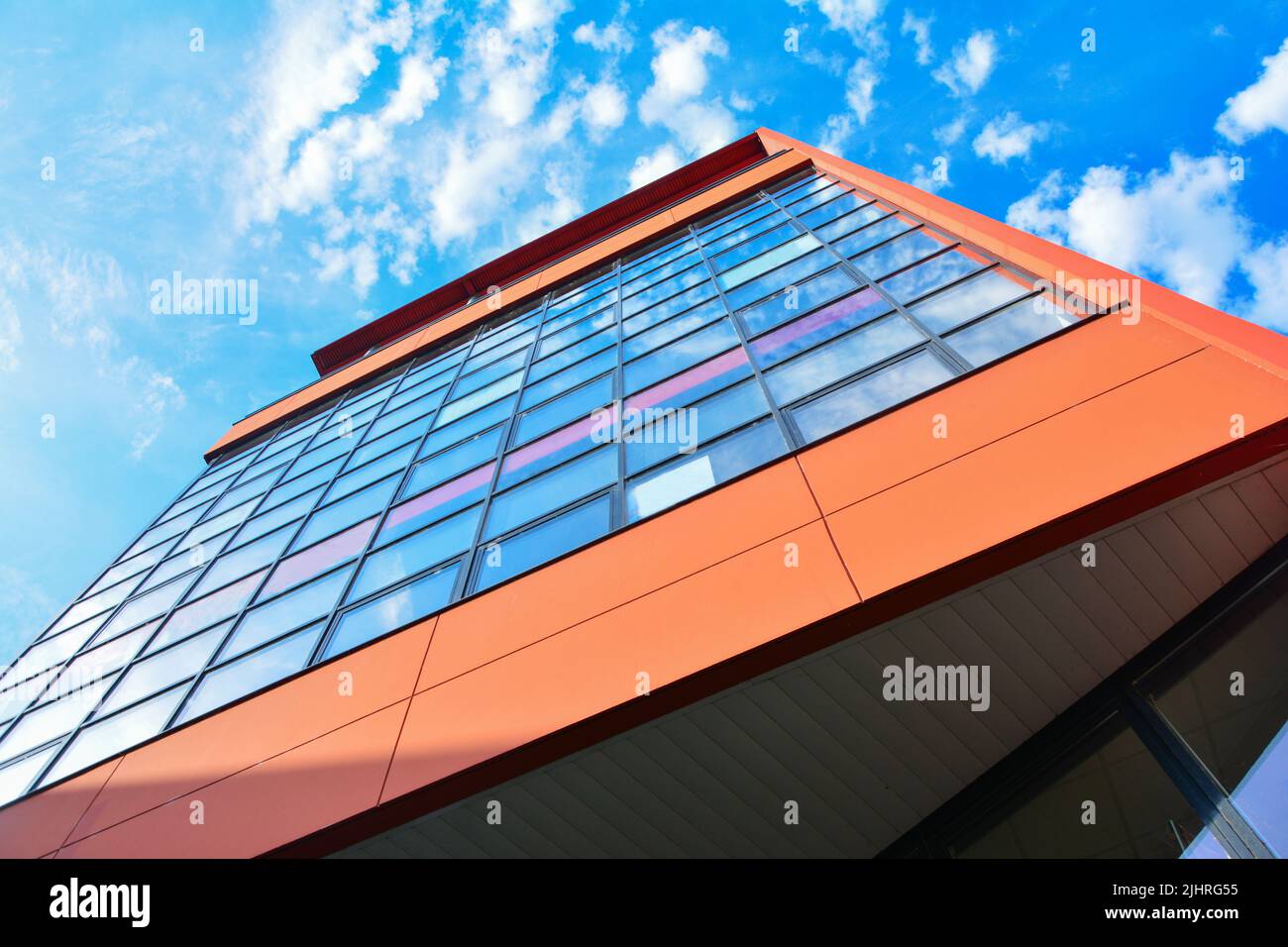 Modern orange building with offices and glass windows Stock Photo - Alamy