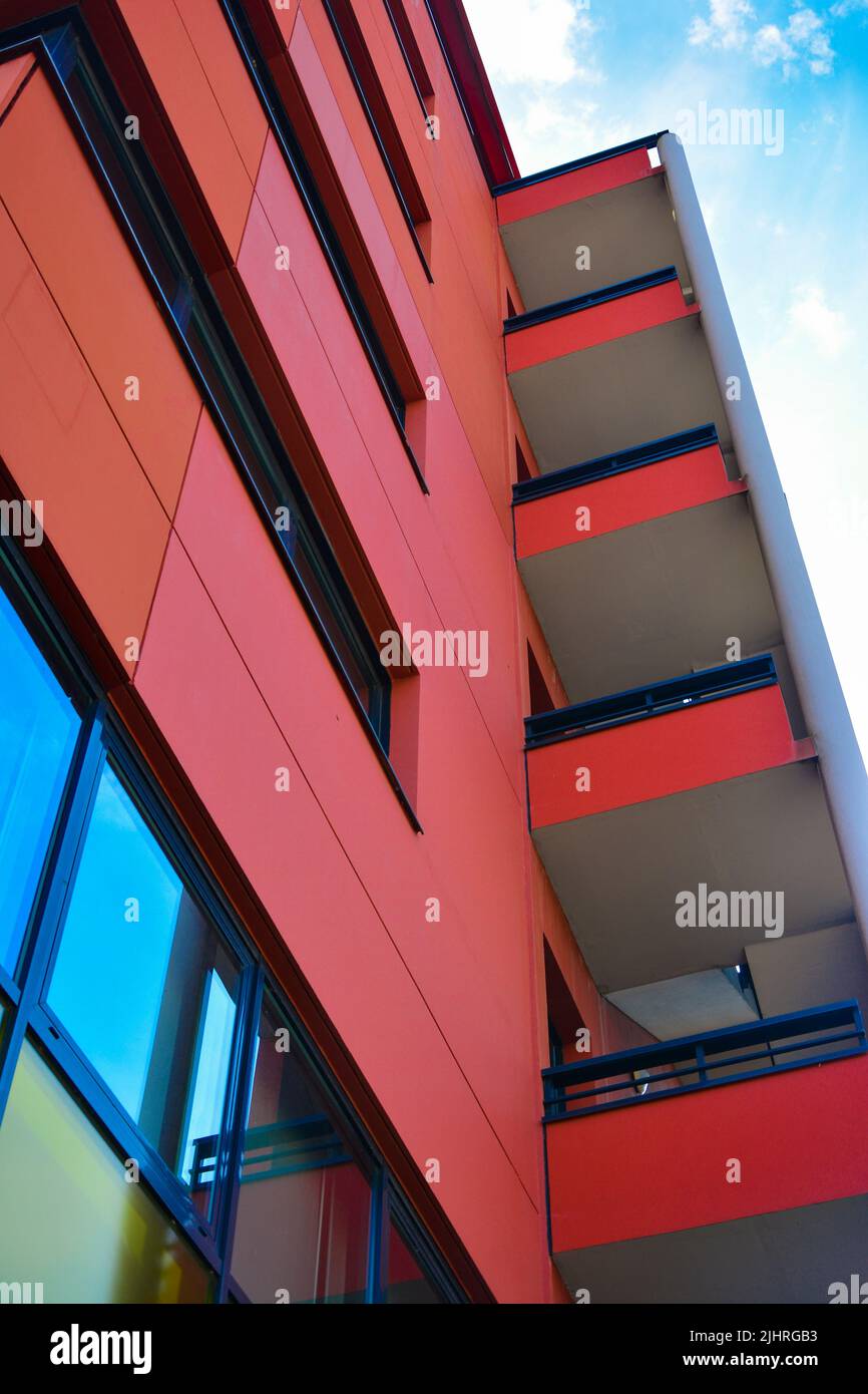 Modern red building with offices and glass windows Stock Photo - Alamy