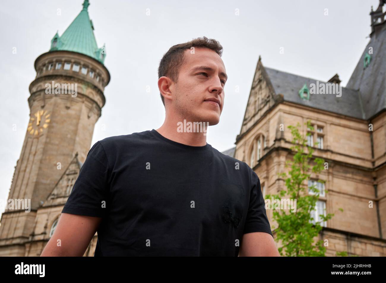 A low angle portrait of a hispanic man in front of State Savings Bank ...
