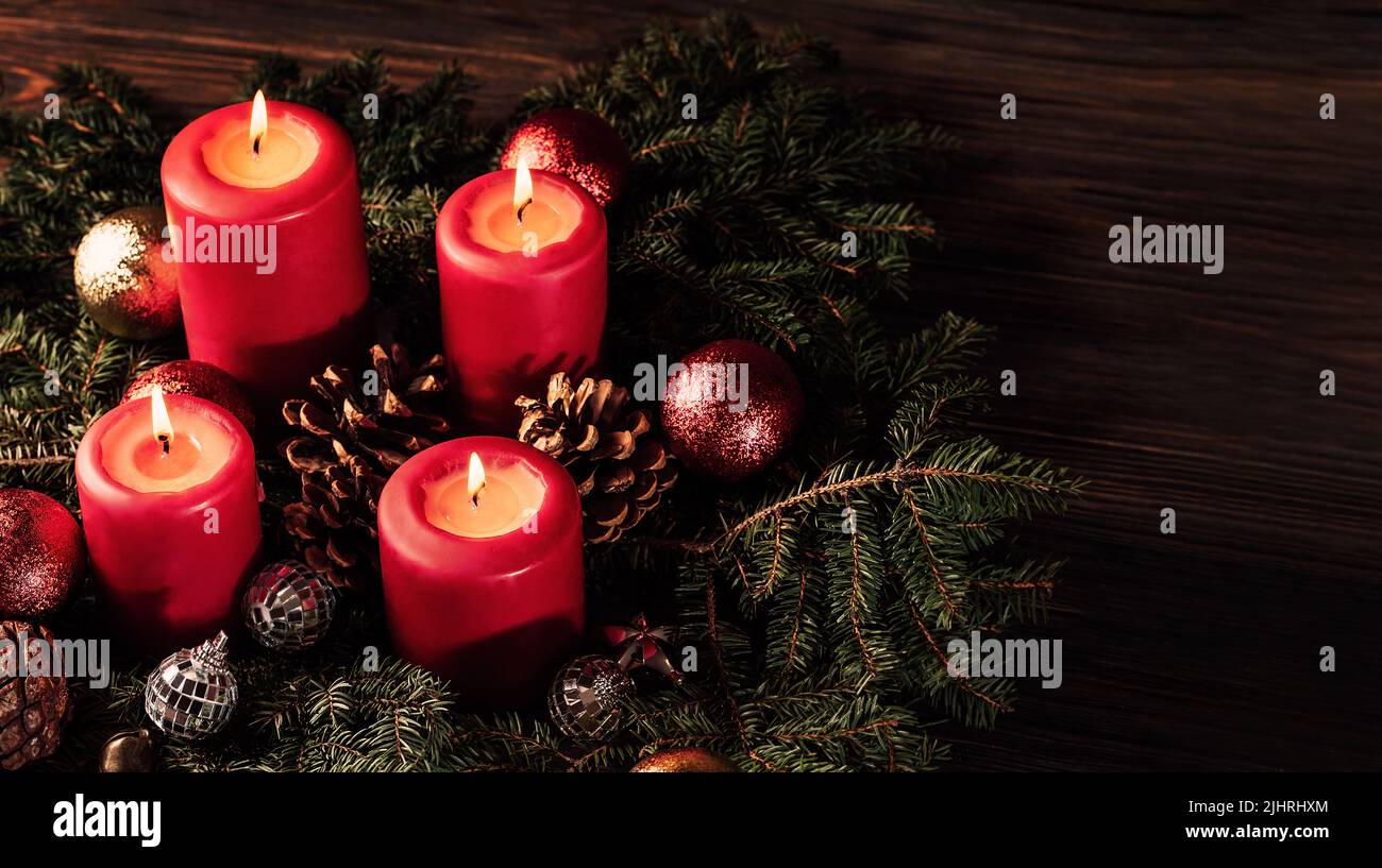 Four Burning Red Advent Candles In Advent Wreath Decoration On Wooden