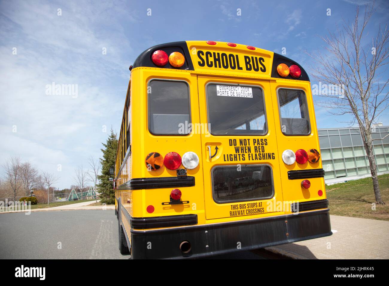 A closeup of a School Bus parked on the road under the sunlight Stock ...