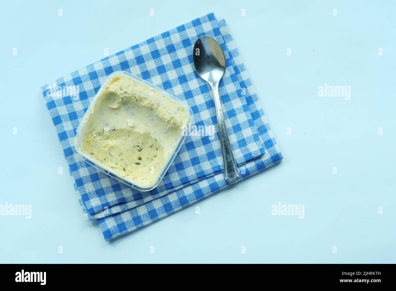 fresh garlic butter in a container on white background Stock Photo - Alamy