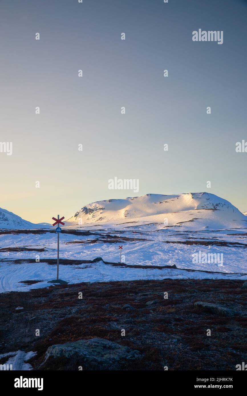 A vertical shot of a hill covered with snow with clear sky Stock Photo ...