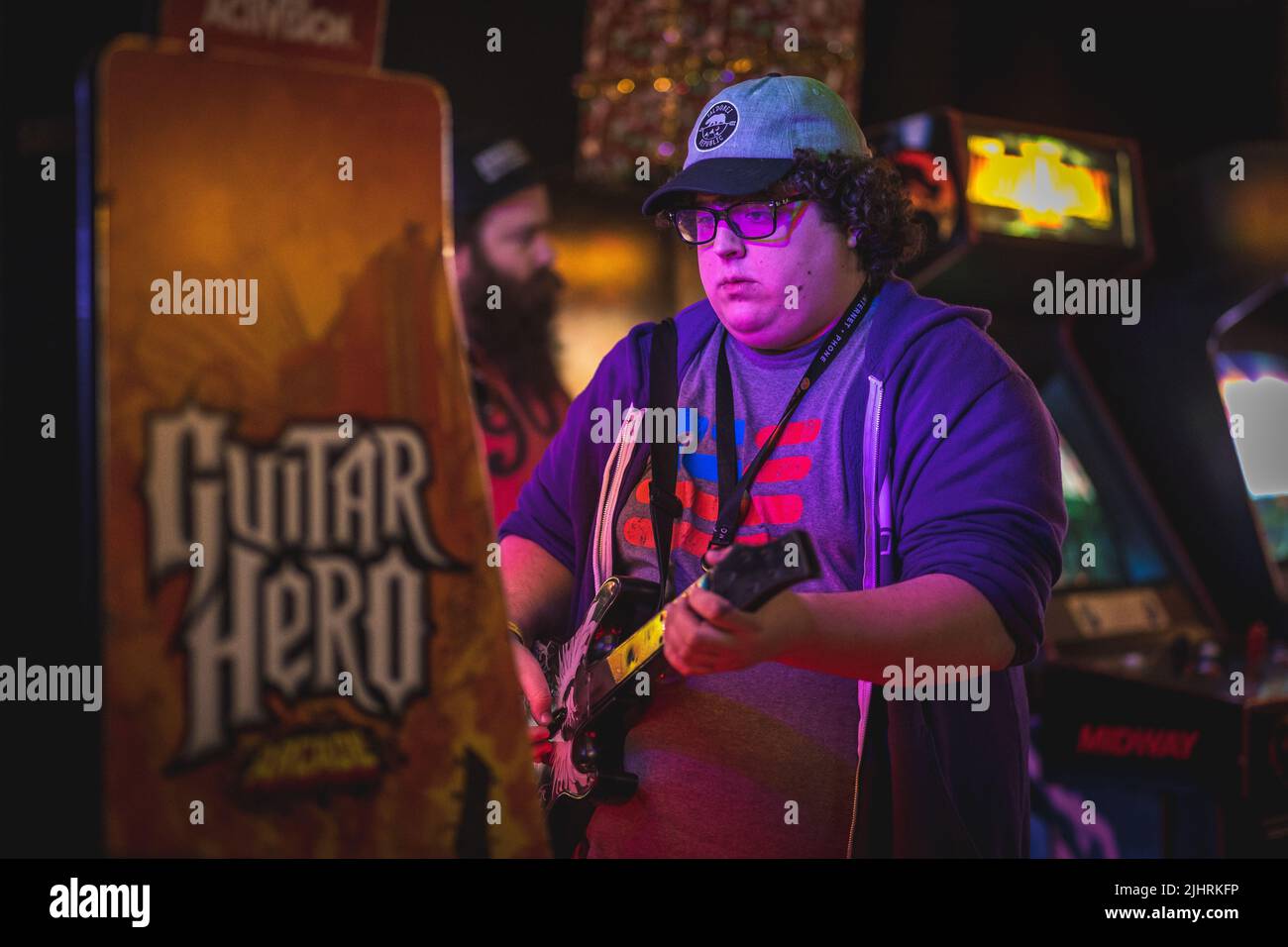 A male guitarist enjoying the arcade game offered by Fort Worth's local ...