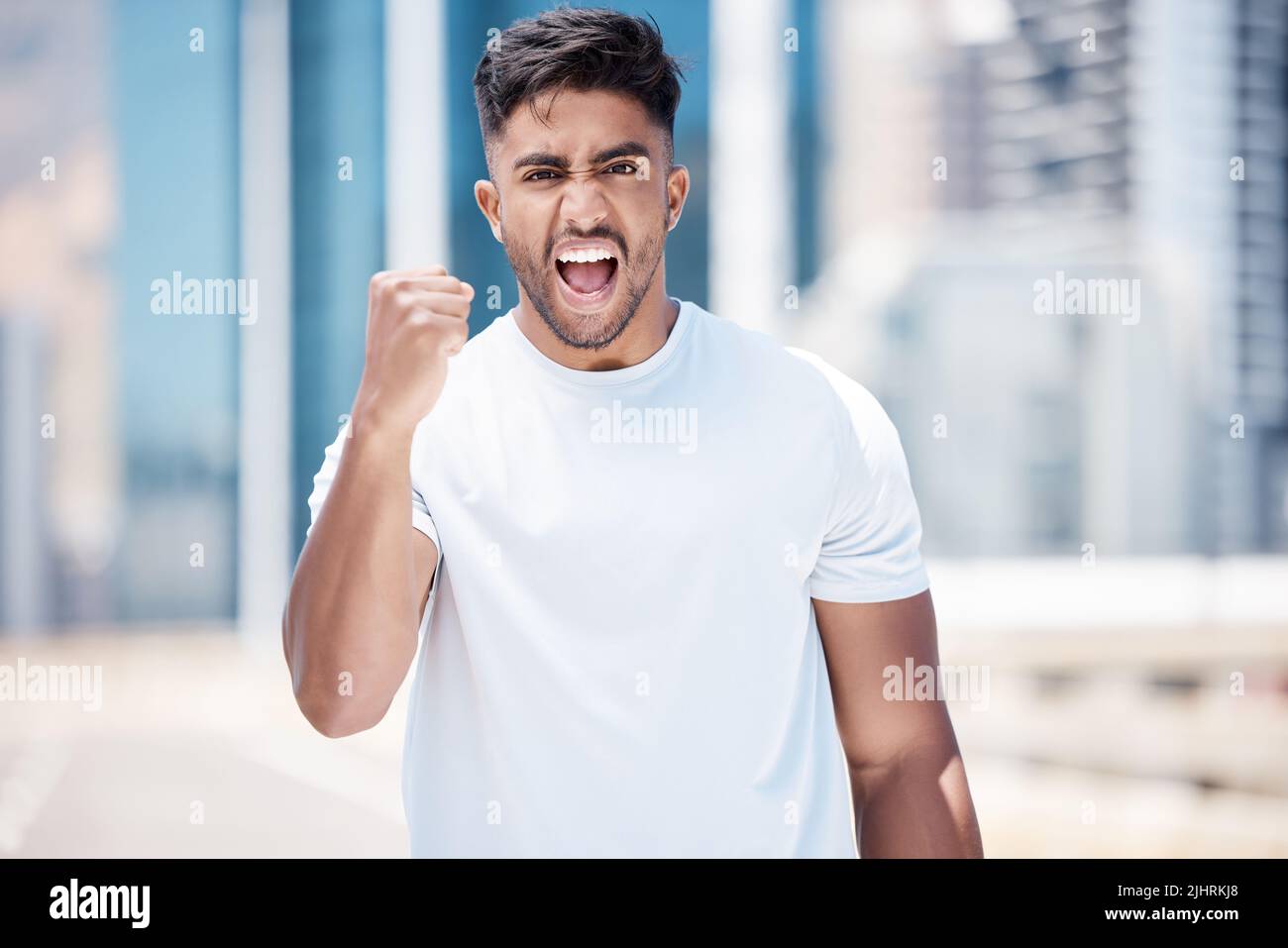 Young mixed race male athlete celebrating a goal, making a winner ...