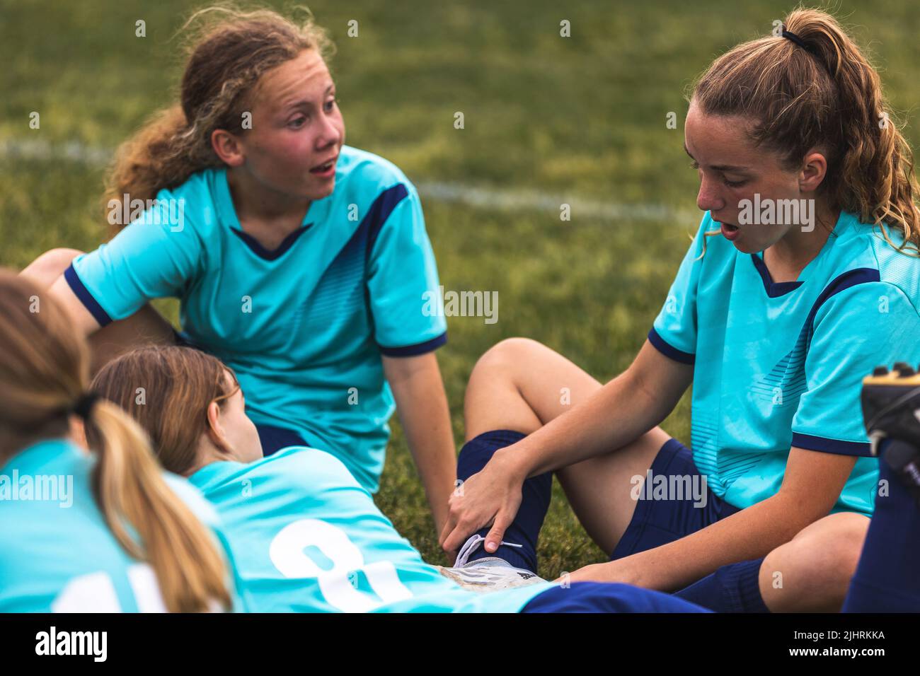 A group of young girls in blue uniforms having a discussion during the ...