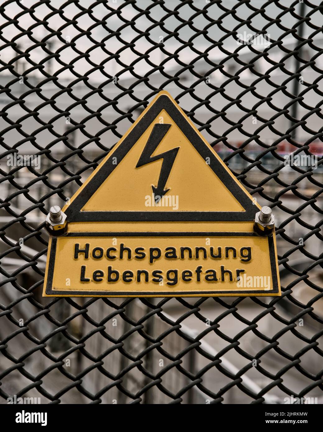 A sign of the high voltage danger to life on a fence Stock Photo - Alamy