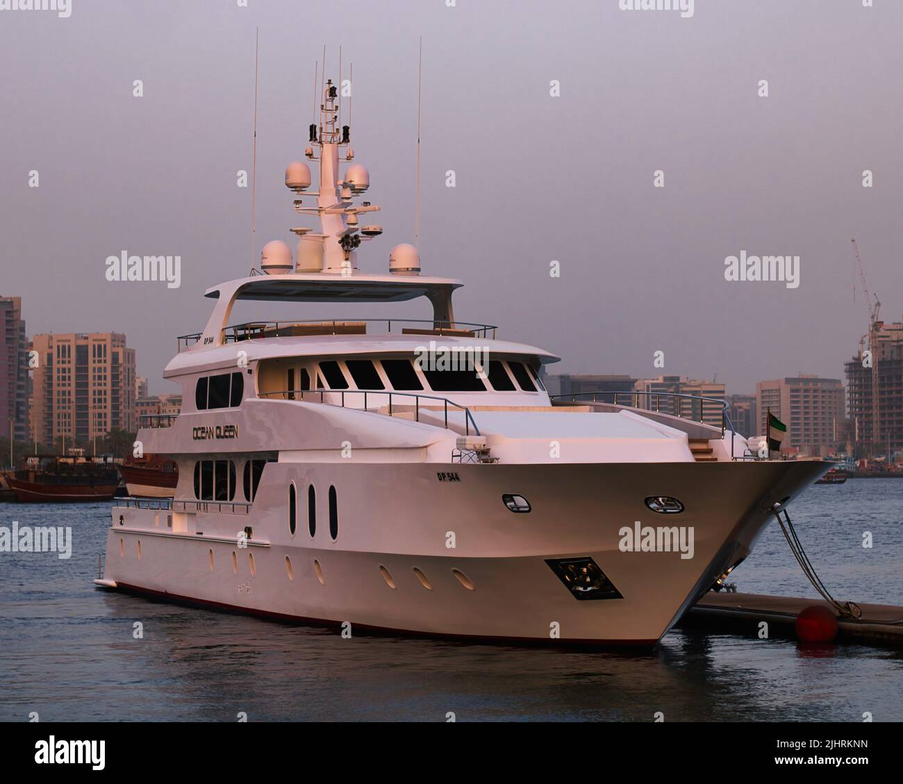 A ship docked on a shore with a view of buildings Stock Photo - Alamy