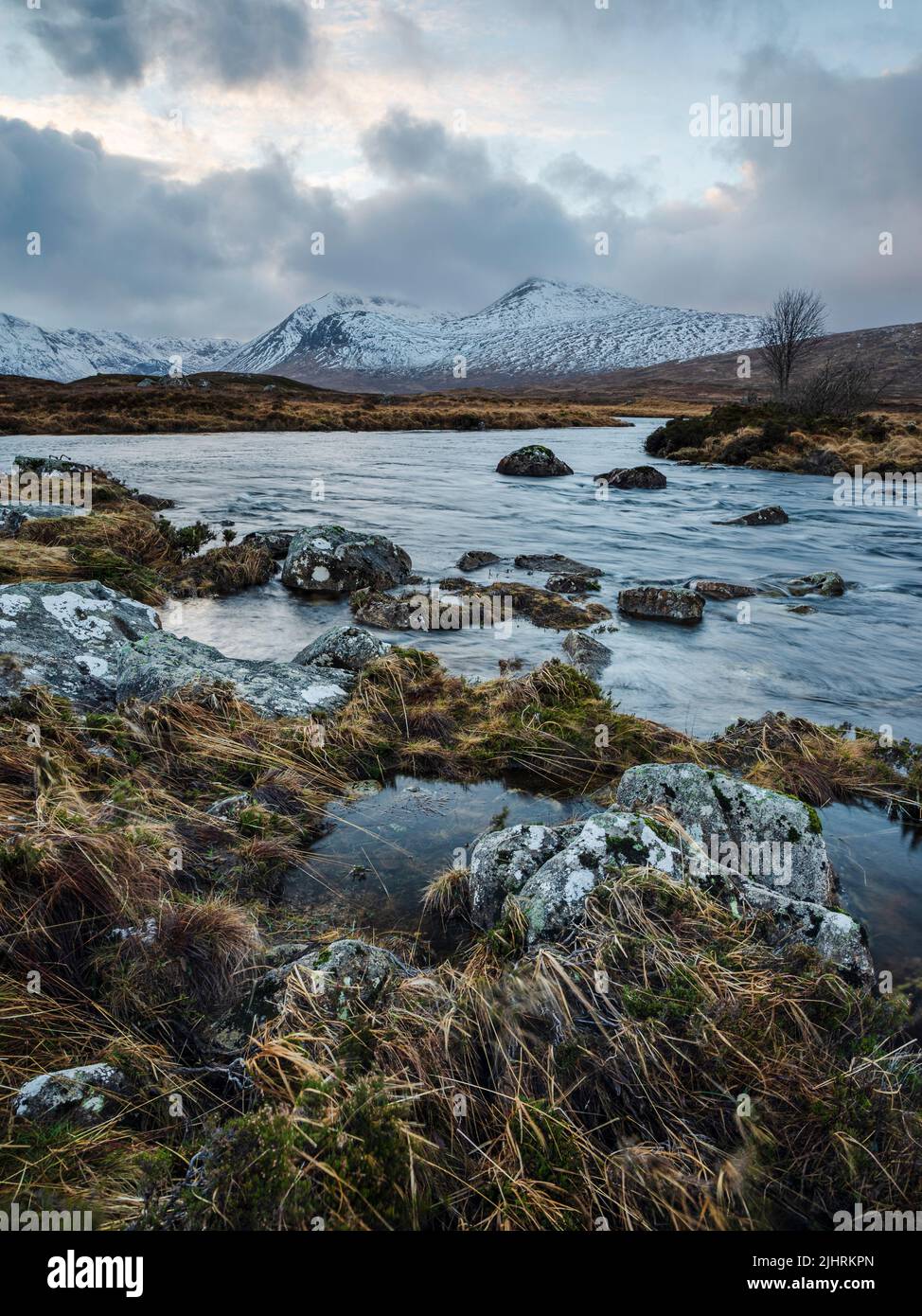 View across Loch Ba towards snowy mountains, Rannoch Moor, Scotland ...