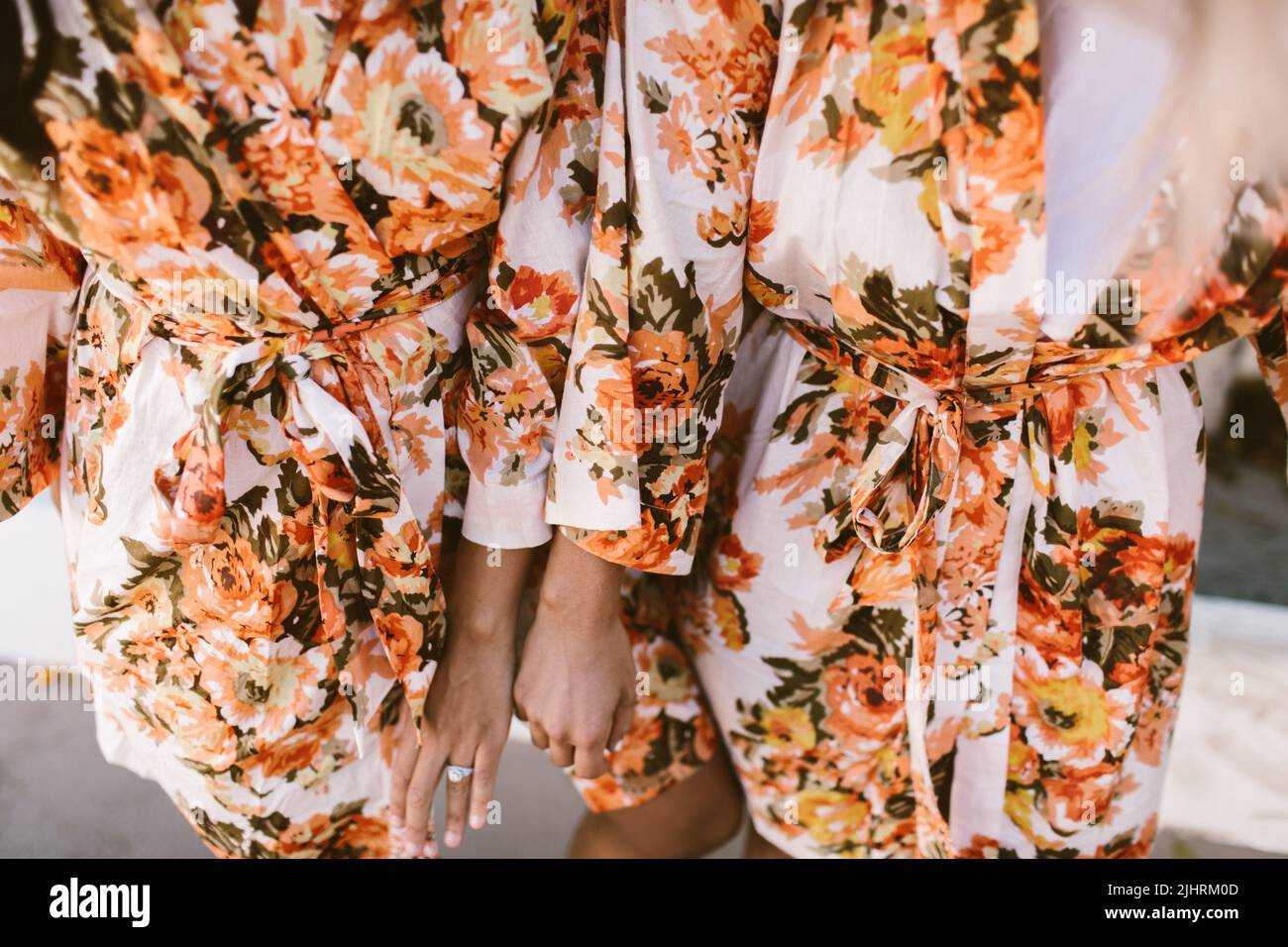A closeup of two women wearing matching floral robes Stock Photo - Alamy