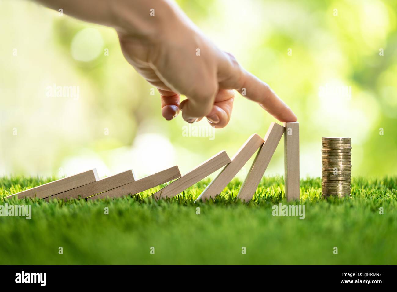 Stopping Domino Falling And Risk Prevention In Office Stock Photo - Alamy