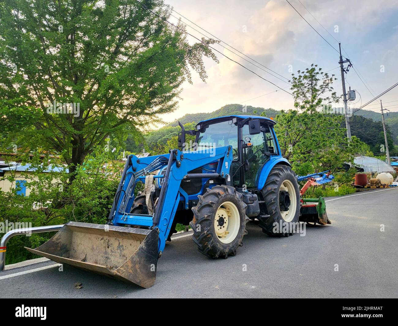 A blue tractor parked on the street Stock Photo - Alamy