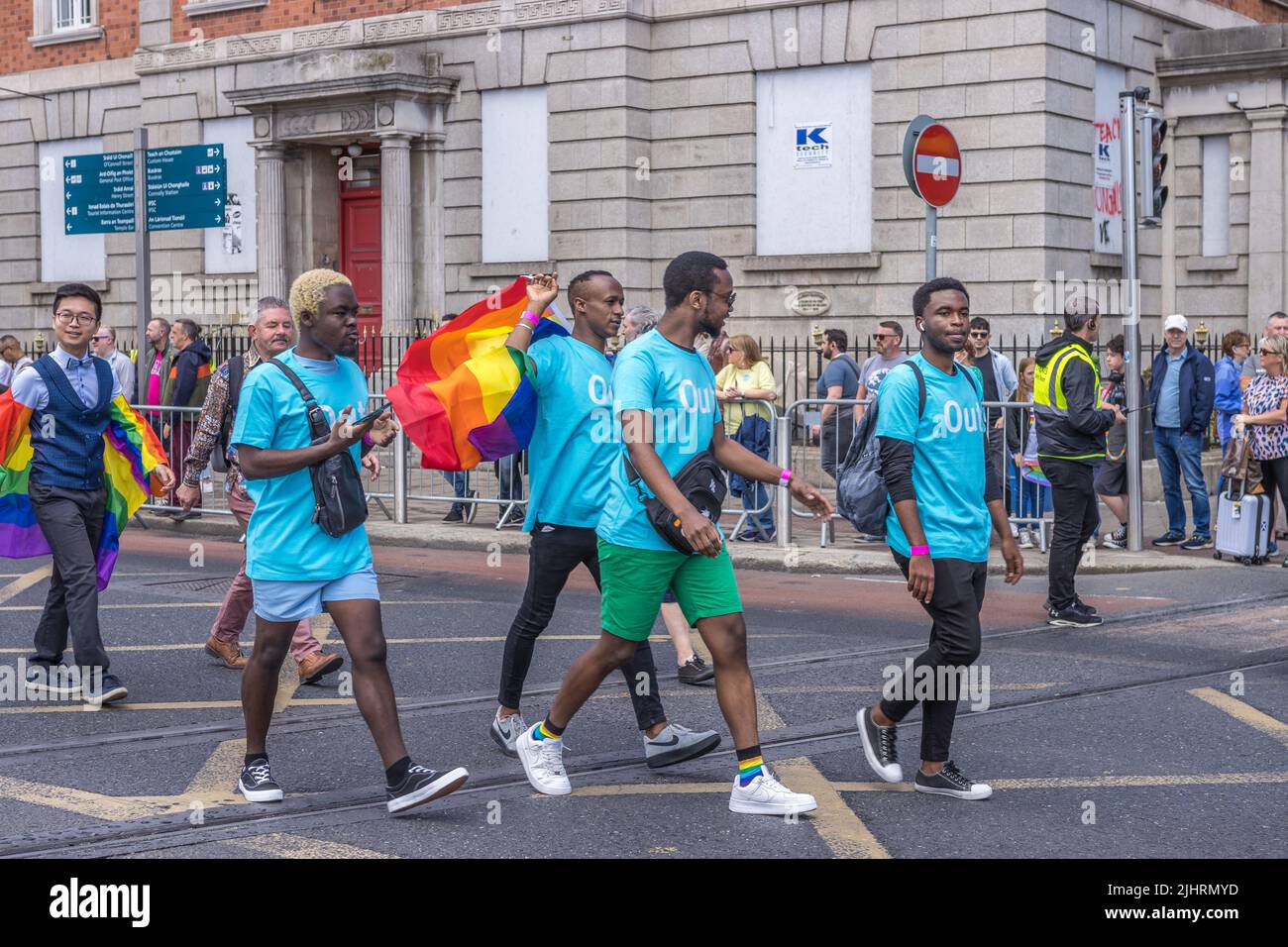 A group of people walking with rainbow flags in the Pride festival in ...