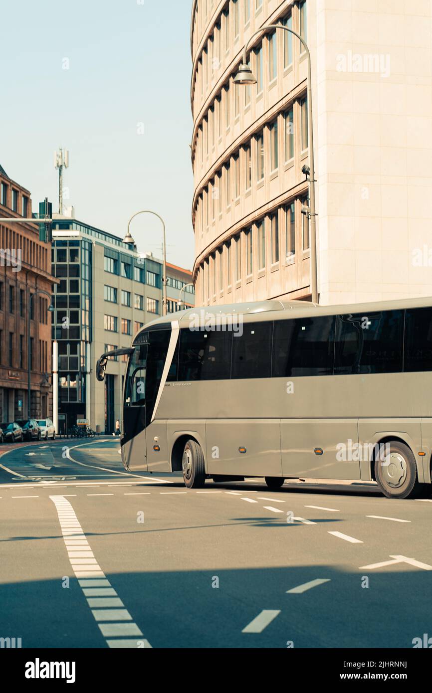 A bus driving on the street near the buildings in Cologne, Germany ...