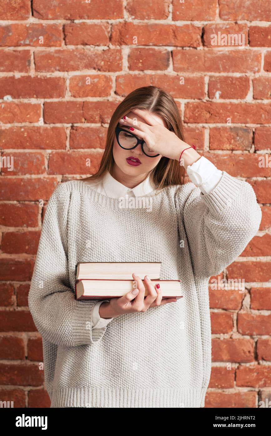 Stress girl with books forgot something important Stock Photo - Alamy