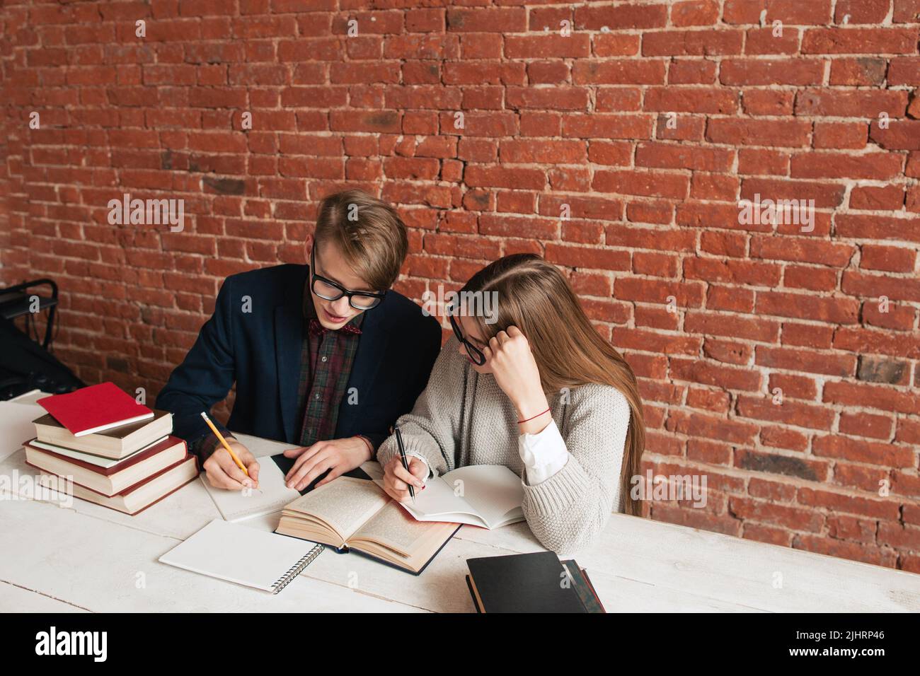Side view on two learning students free space Stock Photo - Alamy
