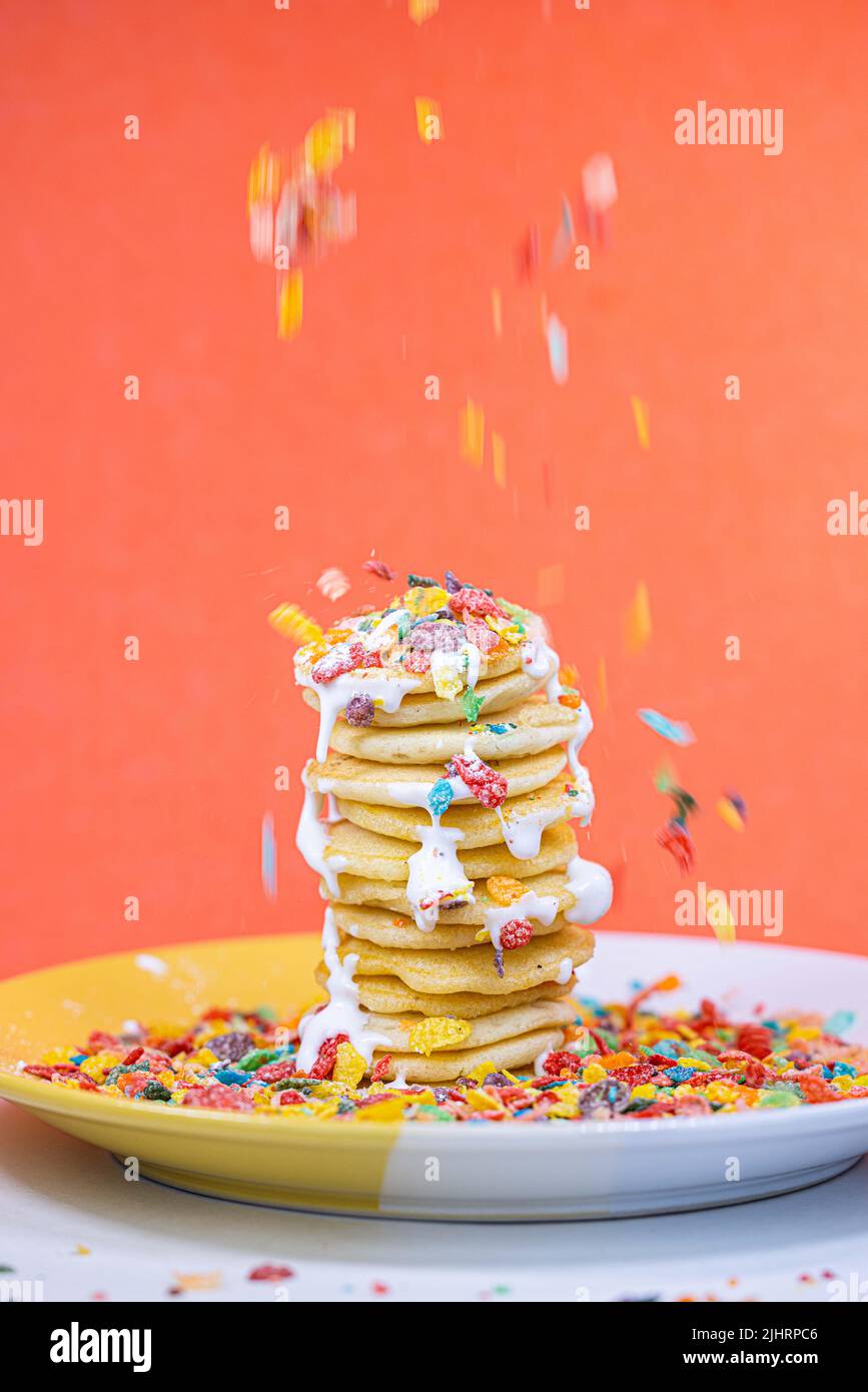 A closeup of a celebratory pancake on a plate with colorful oatmeal ...