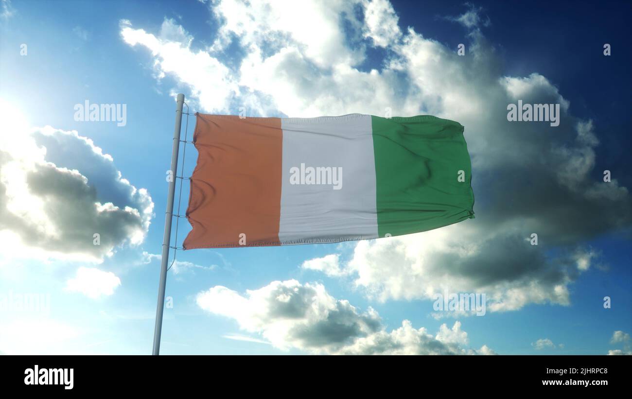 Flag of Ivory Coast waving at wind against beautiful blue sky. 3d ...