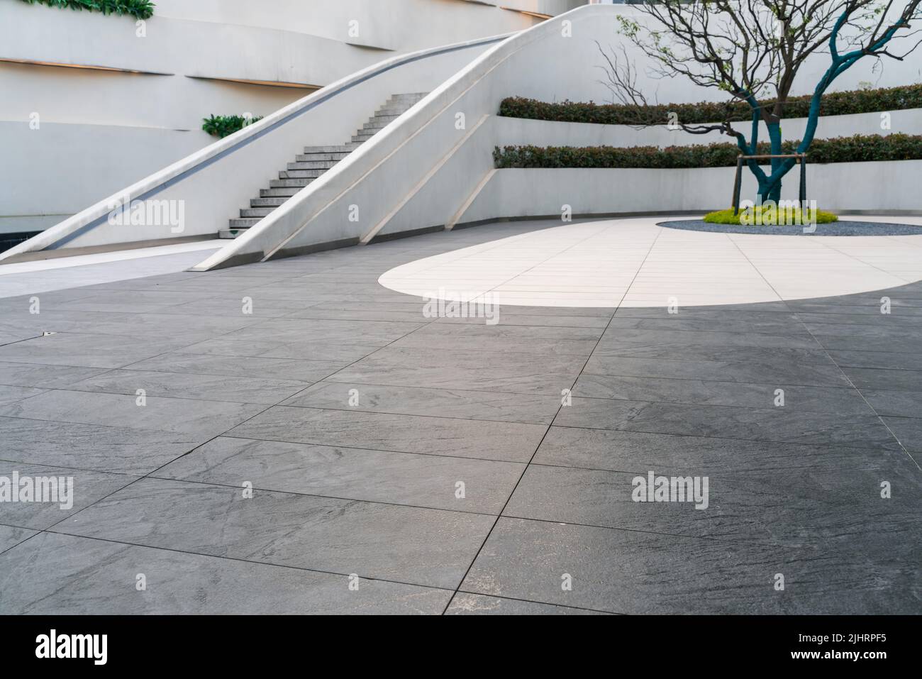 The gray empty ground floor in front of modern office building exterior ...