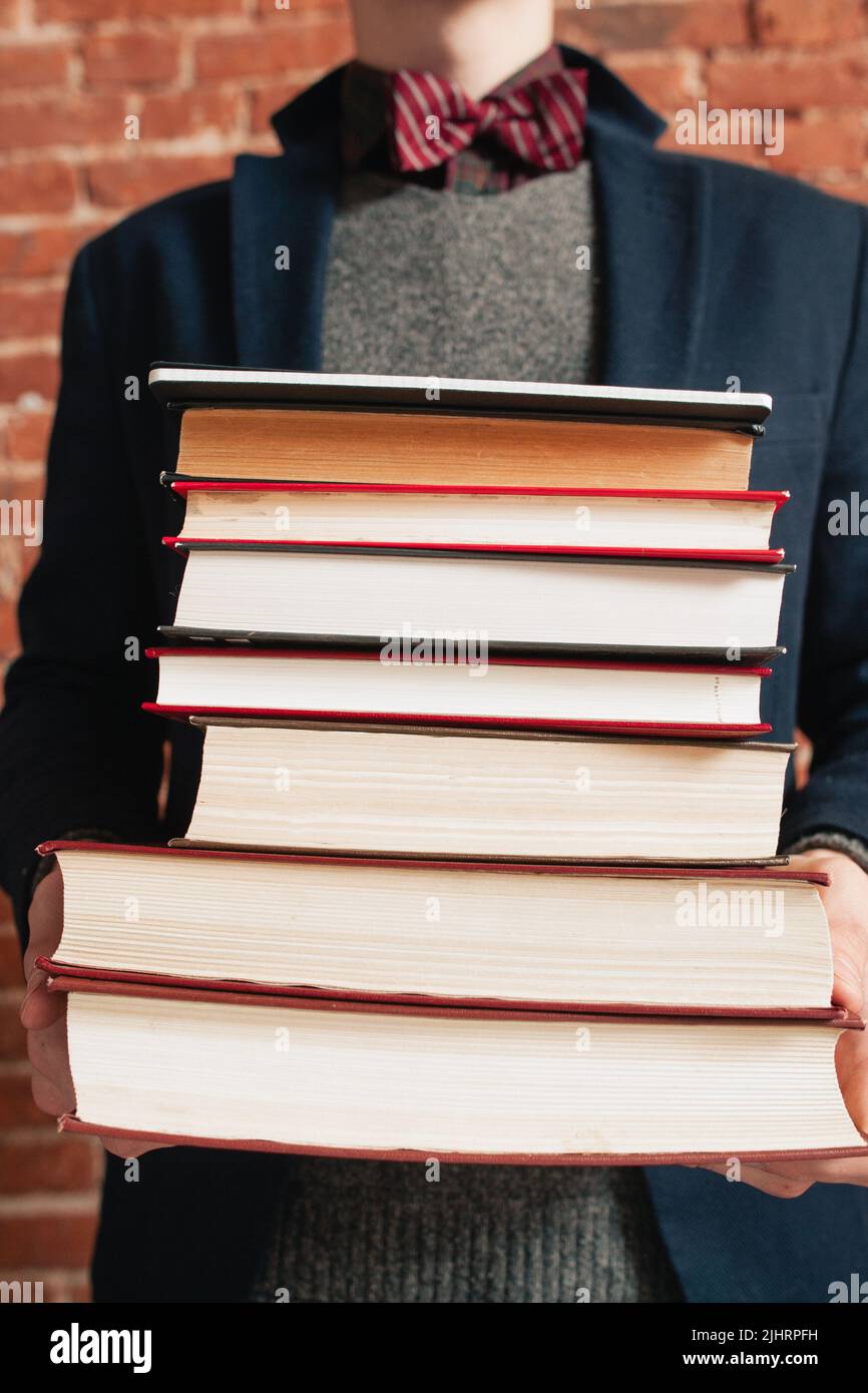 Unrecognizable man holding stack of books Stock Photo - Alamy