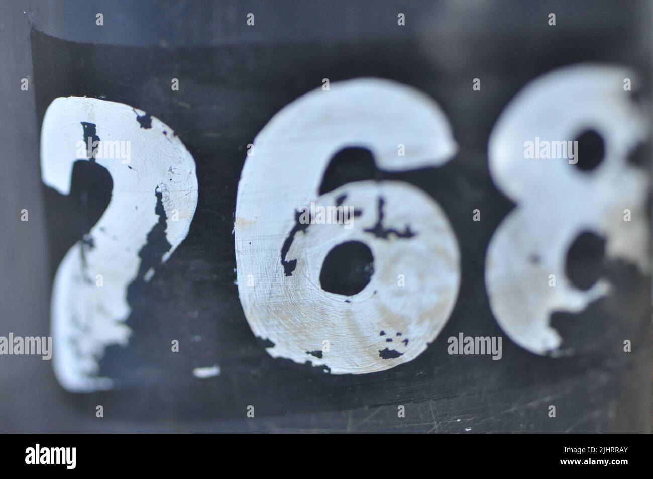 Miniature effect photo of weathered street number Stock Photo - Alamy