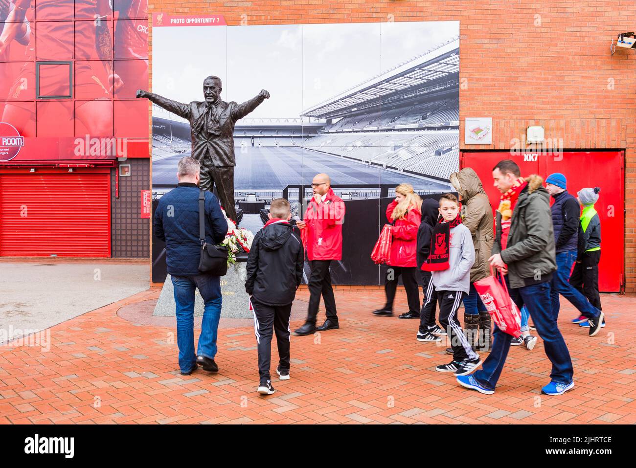 Liverpool F.C. supporters next to the Bill Shankly statue at Anfield ...