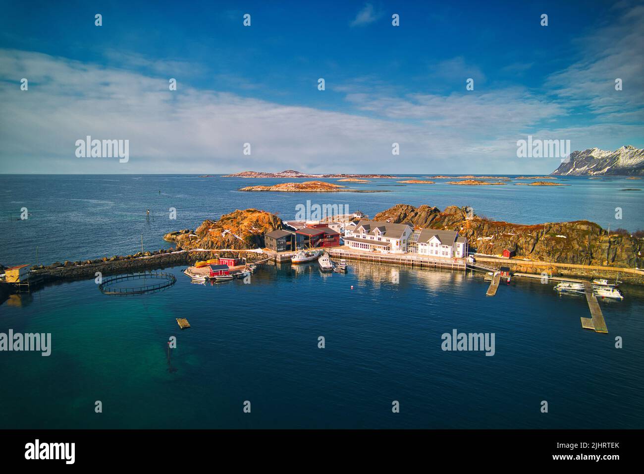An aerial view of Hamn in Senja island surrounded by a blue ocean in ...