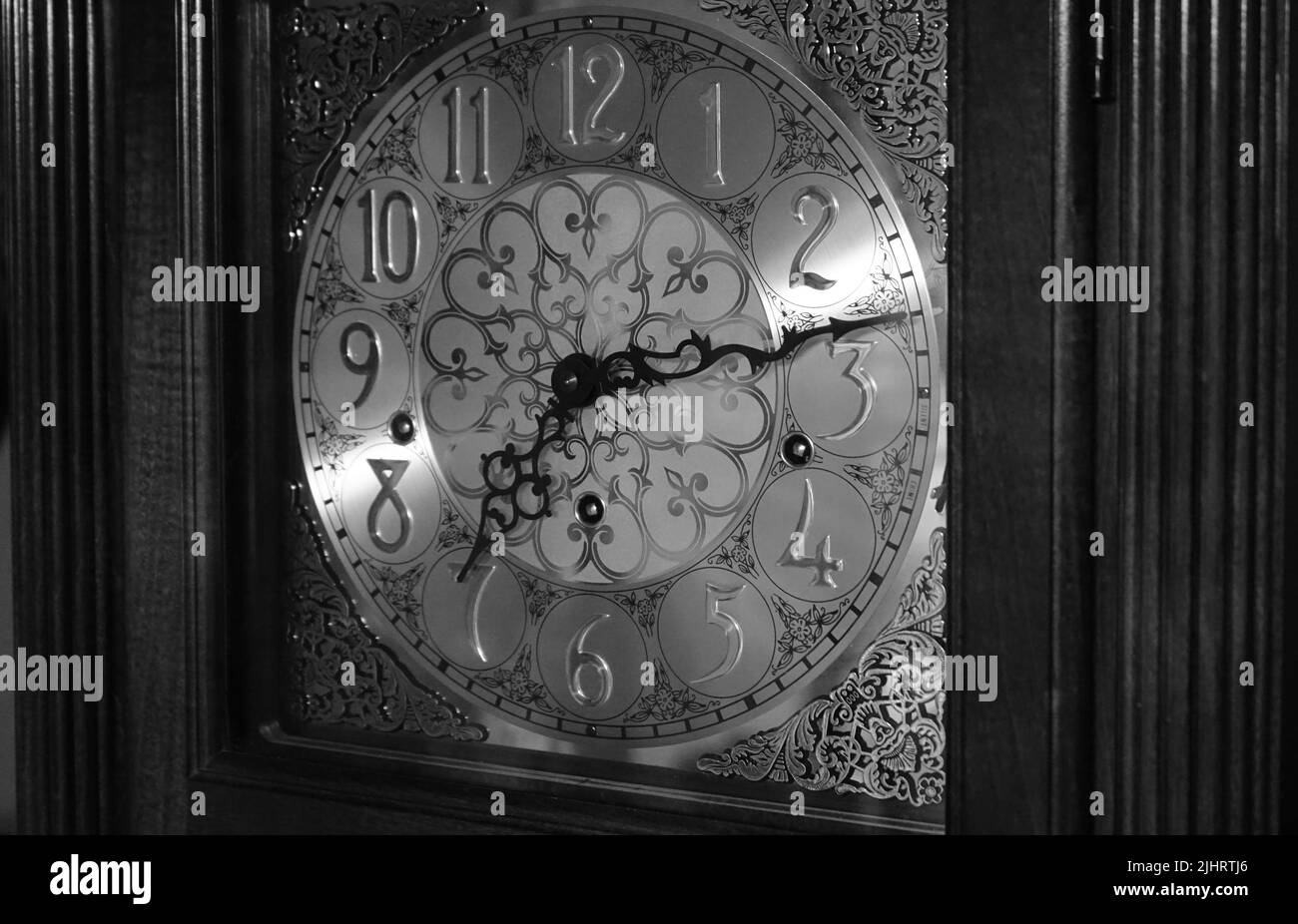 A grayscale closeup of an old antique clock on a wall Stock Photo - Alamy