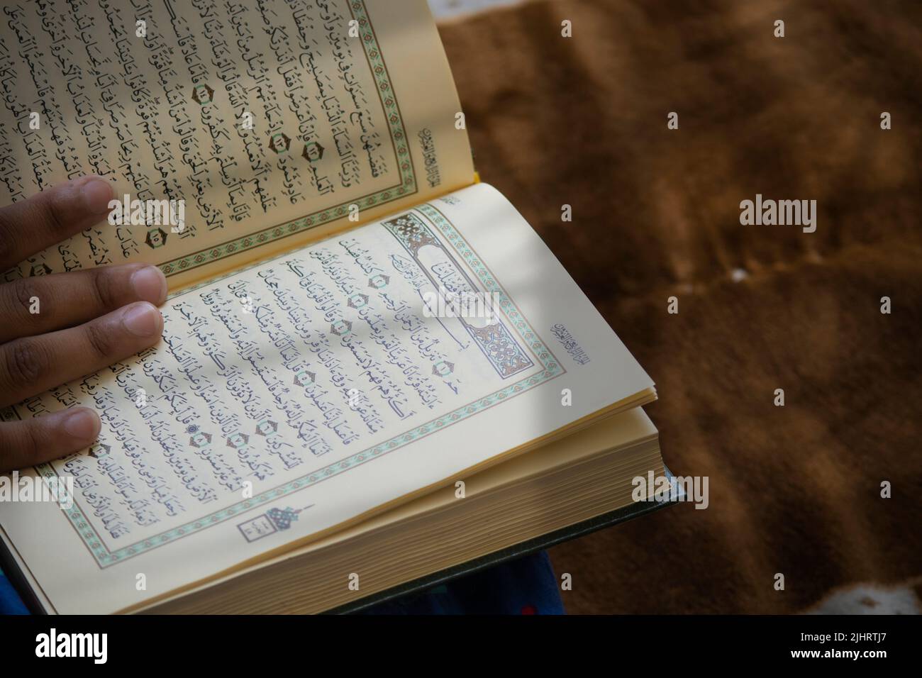 A person reading holy Quran Stock Photo - Alamy