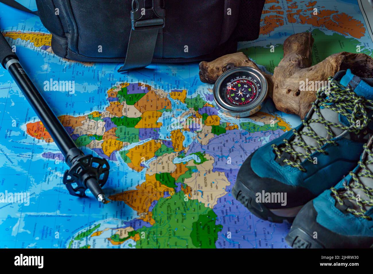 boots, backpack, walking stick and compass, trekking equipment on a map ...