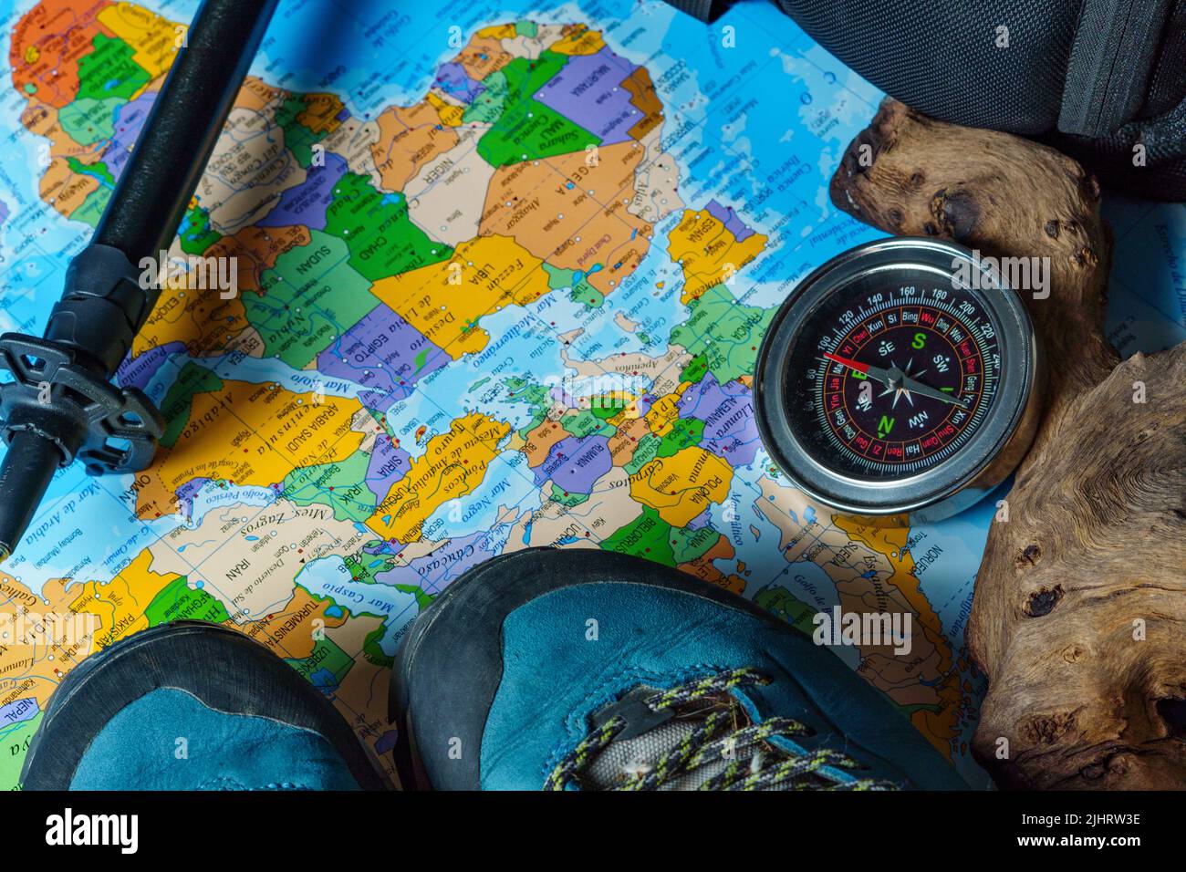 boots, backpack, walking stick and compass, trekking equipment on a map ...