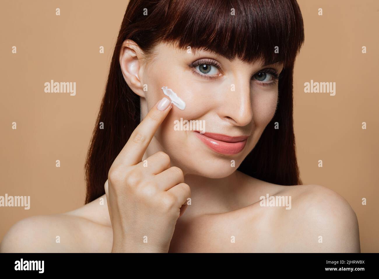 Beautiful Ginger Girl Applying Special Cream On Her Face With Healthy