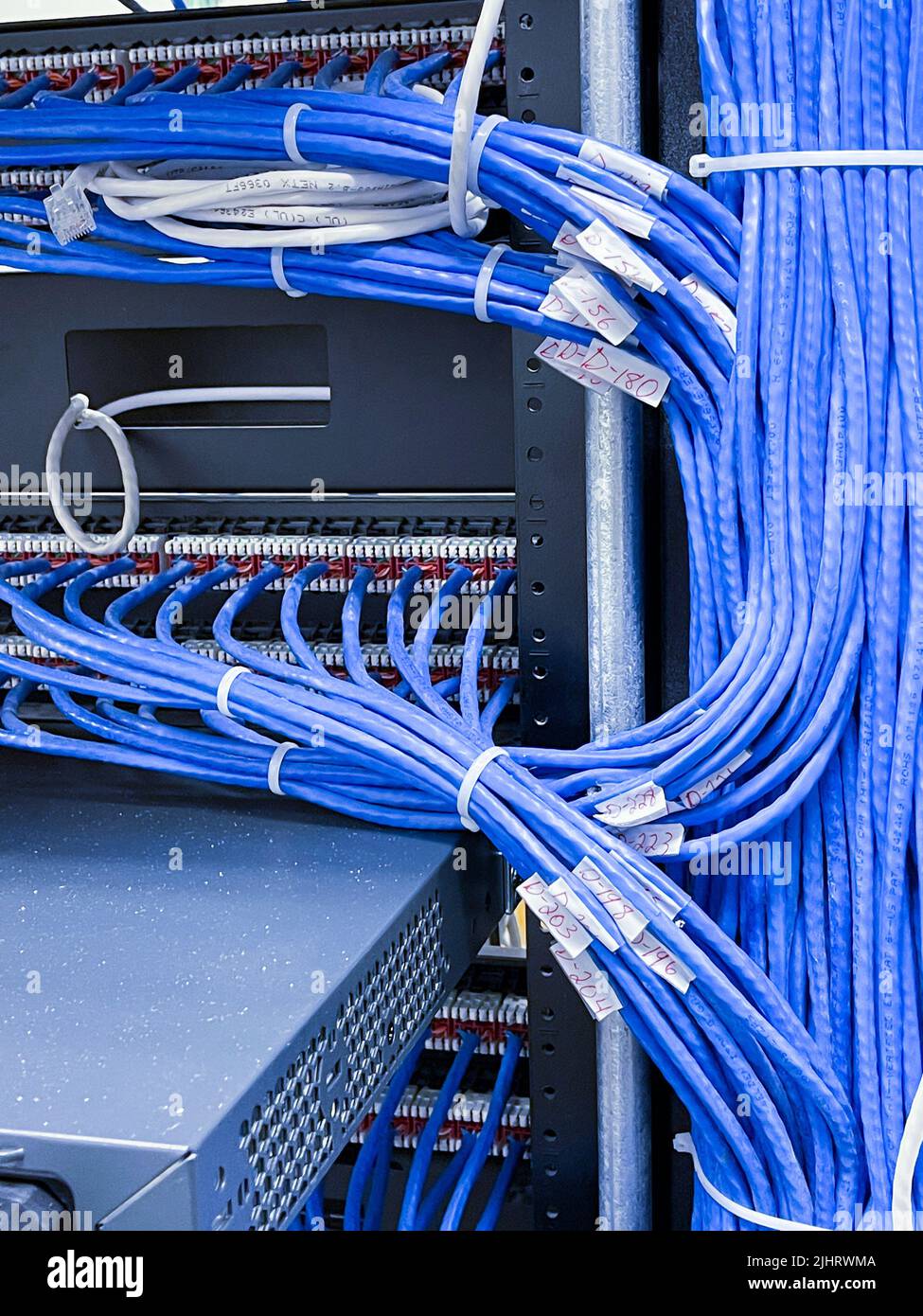 A vertical closeup of plugged in blue cables Stock Photo - Alamy