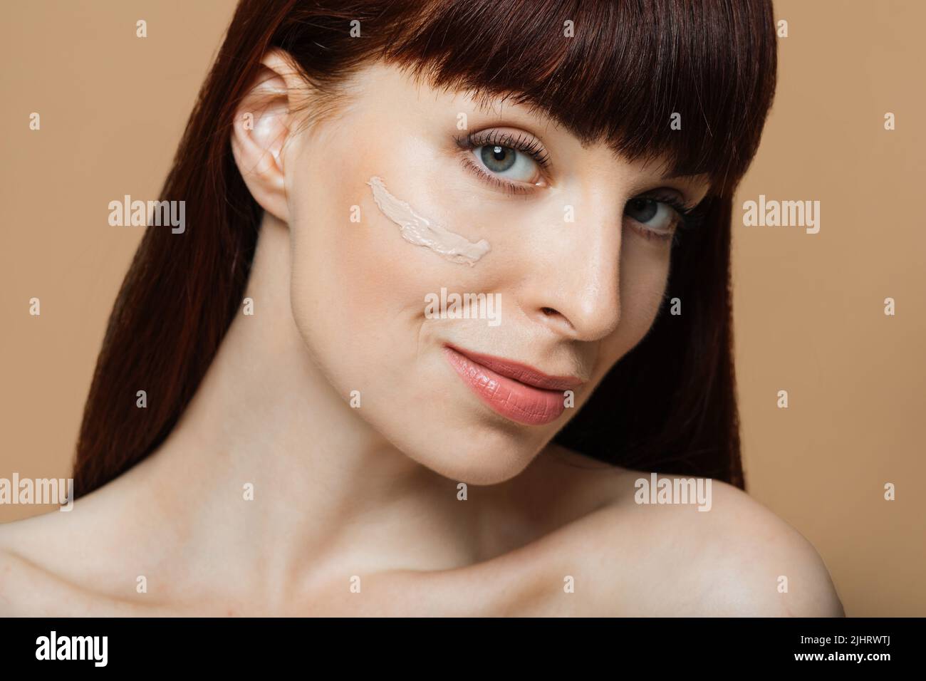 Beautiful young female with smooth skin and fresh makeup with liquid ...